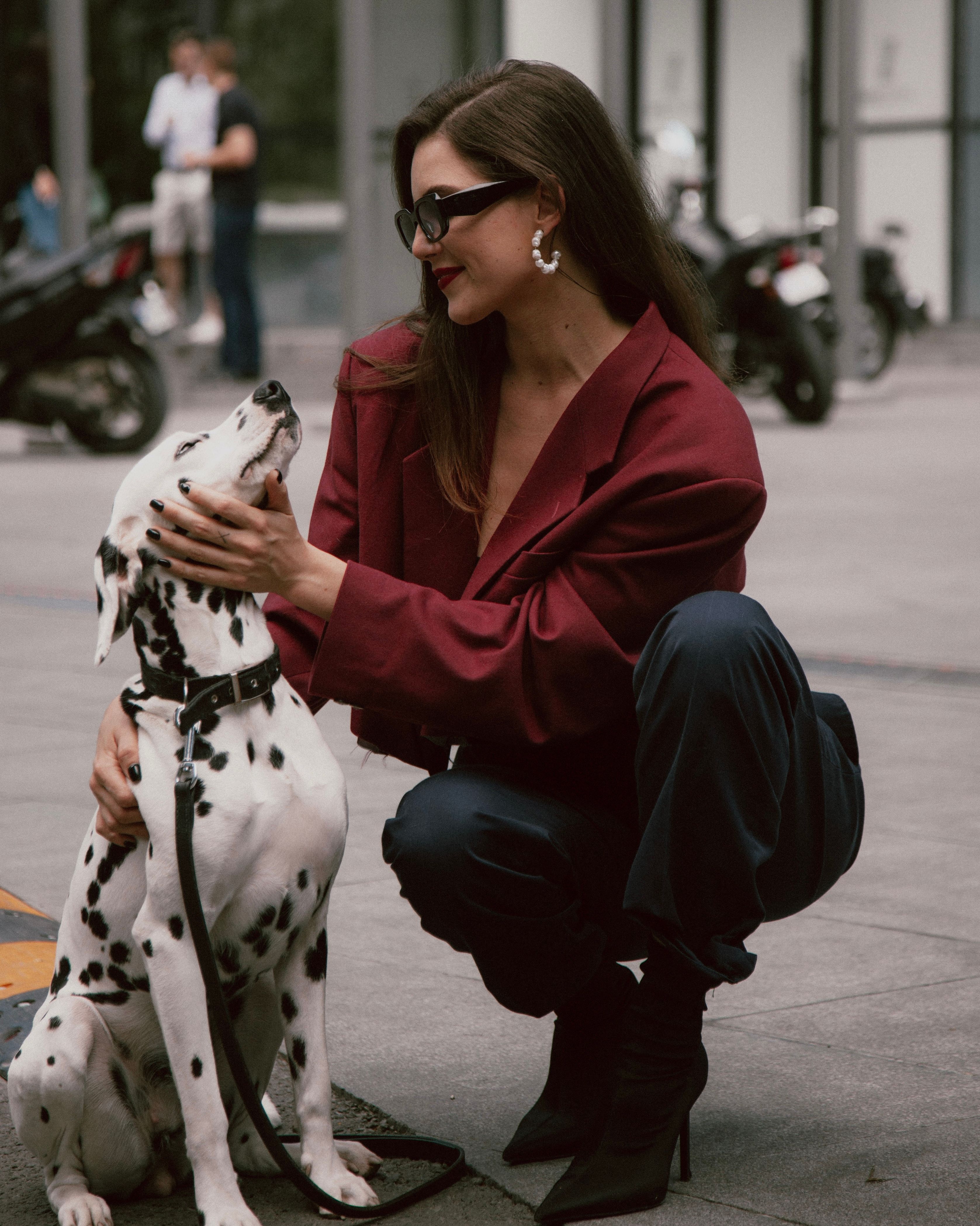 Stylish Woman with Dalmatian in Urban Setting · Free Stock Photo