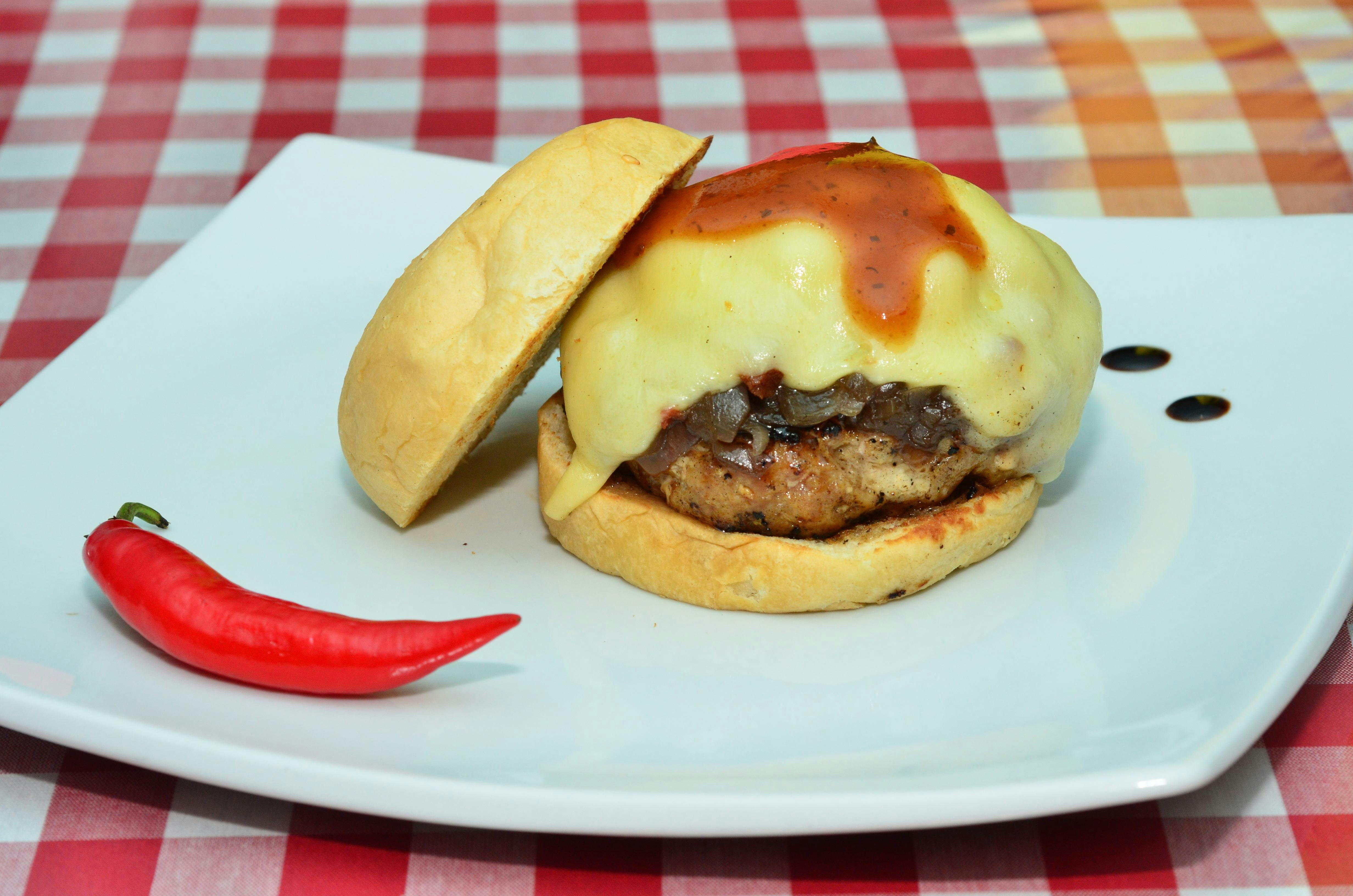 Delicious Cheeseburger with Chili Pepper on Plate · Free Stock Photo