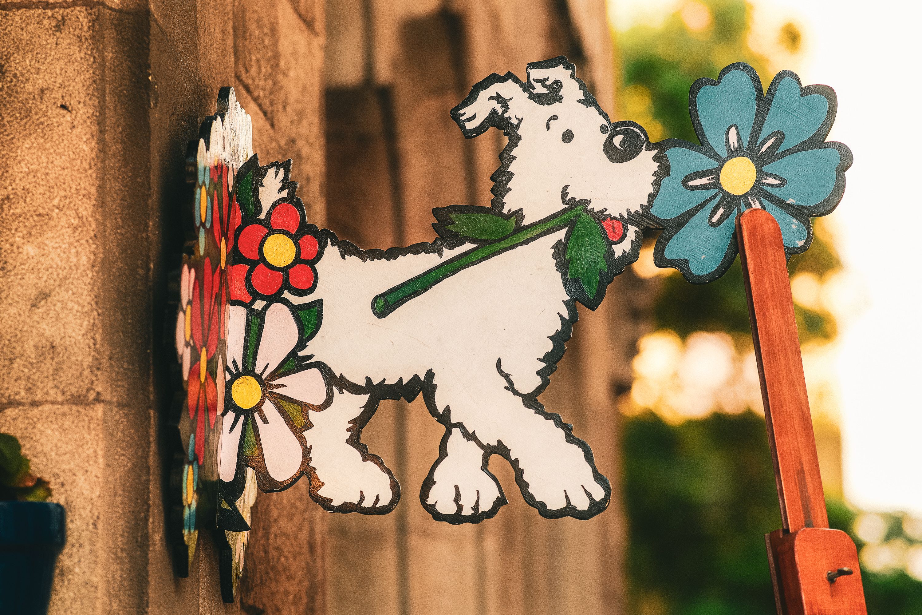 Artistic Dog Sign with Colorful Flowers · Free Stock Photo