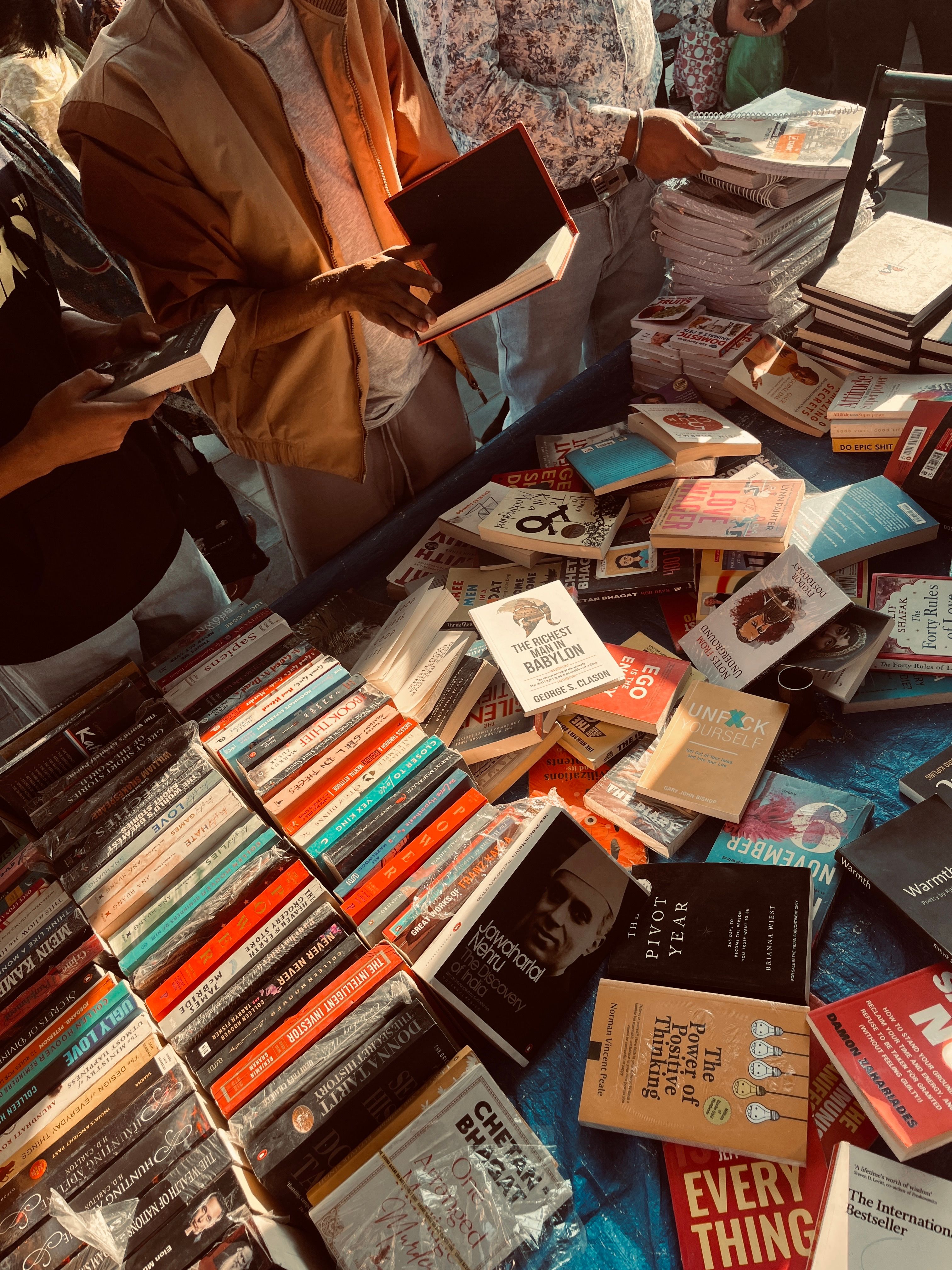 Outdoor Book Market Stall with Customers Browsing · Free Stock Photo