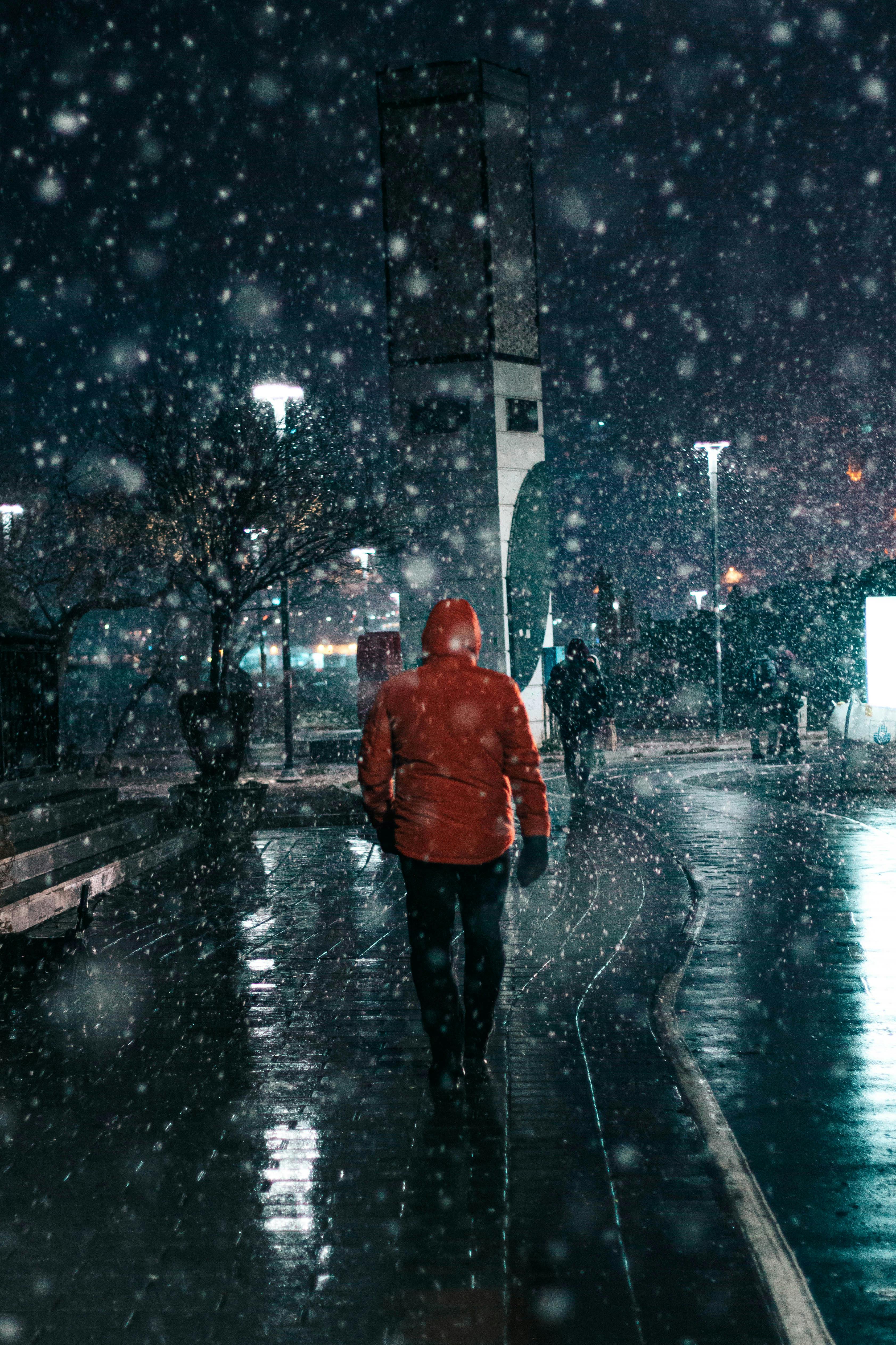 Snowy Night Walk in İstanbul: Man in Red Coat · Free Stock Photo