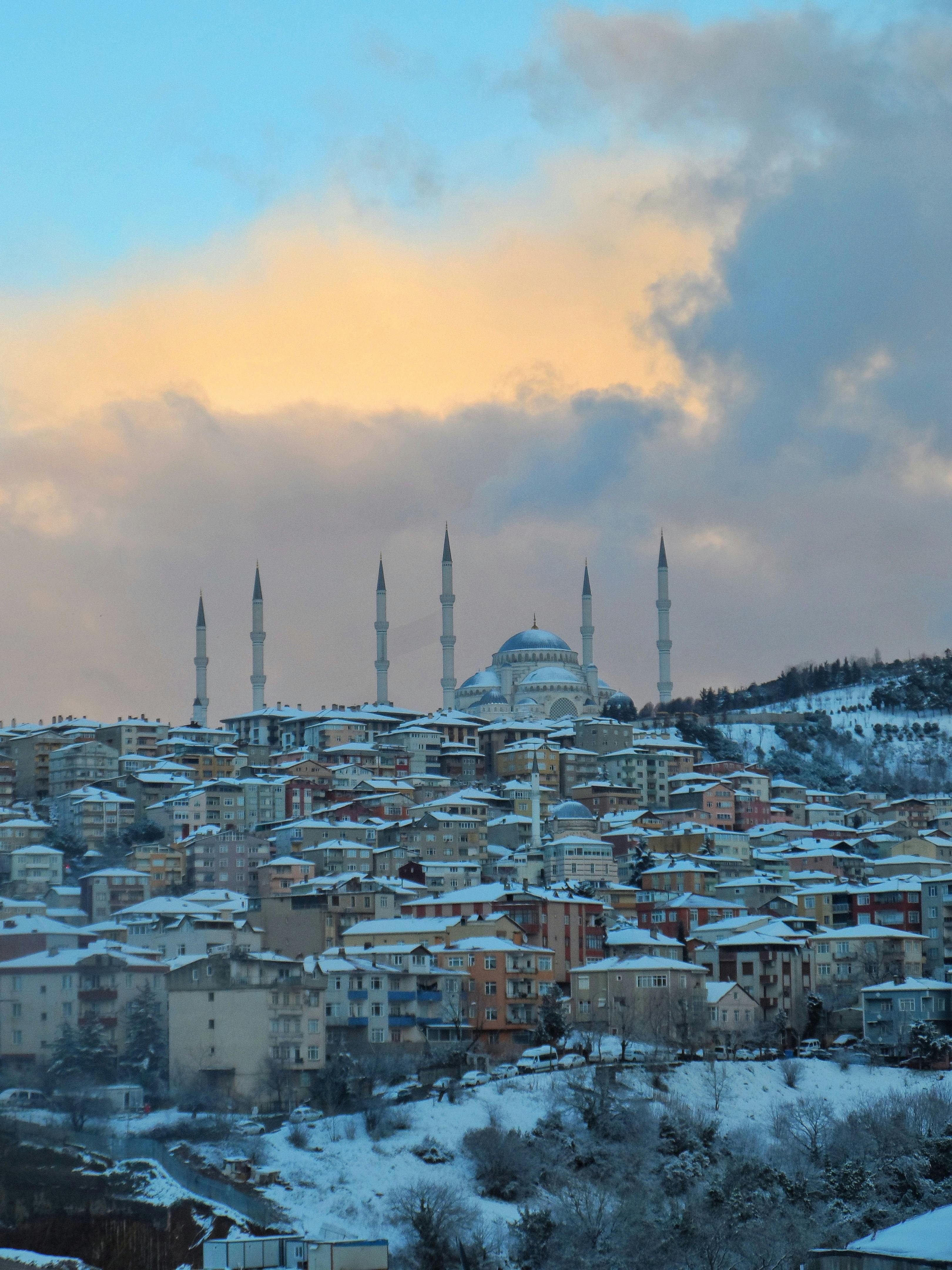 Snowy Cityscape with Majestic Mosque Spires · Free Stock Photo