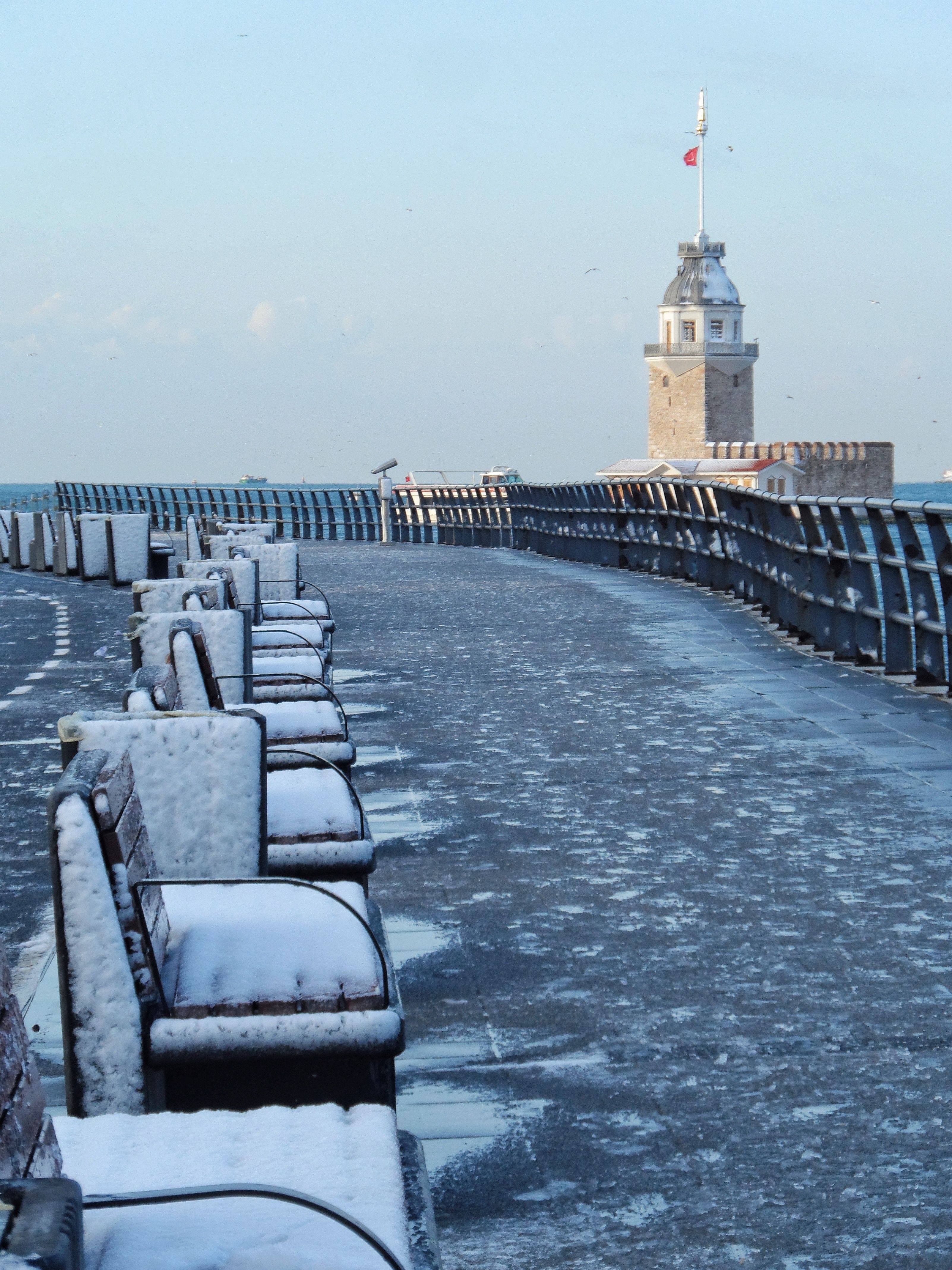 Snowy Walkway with Iconic Tower in Winter · Free Stock Photo