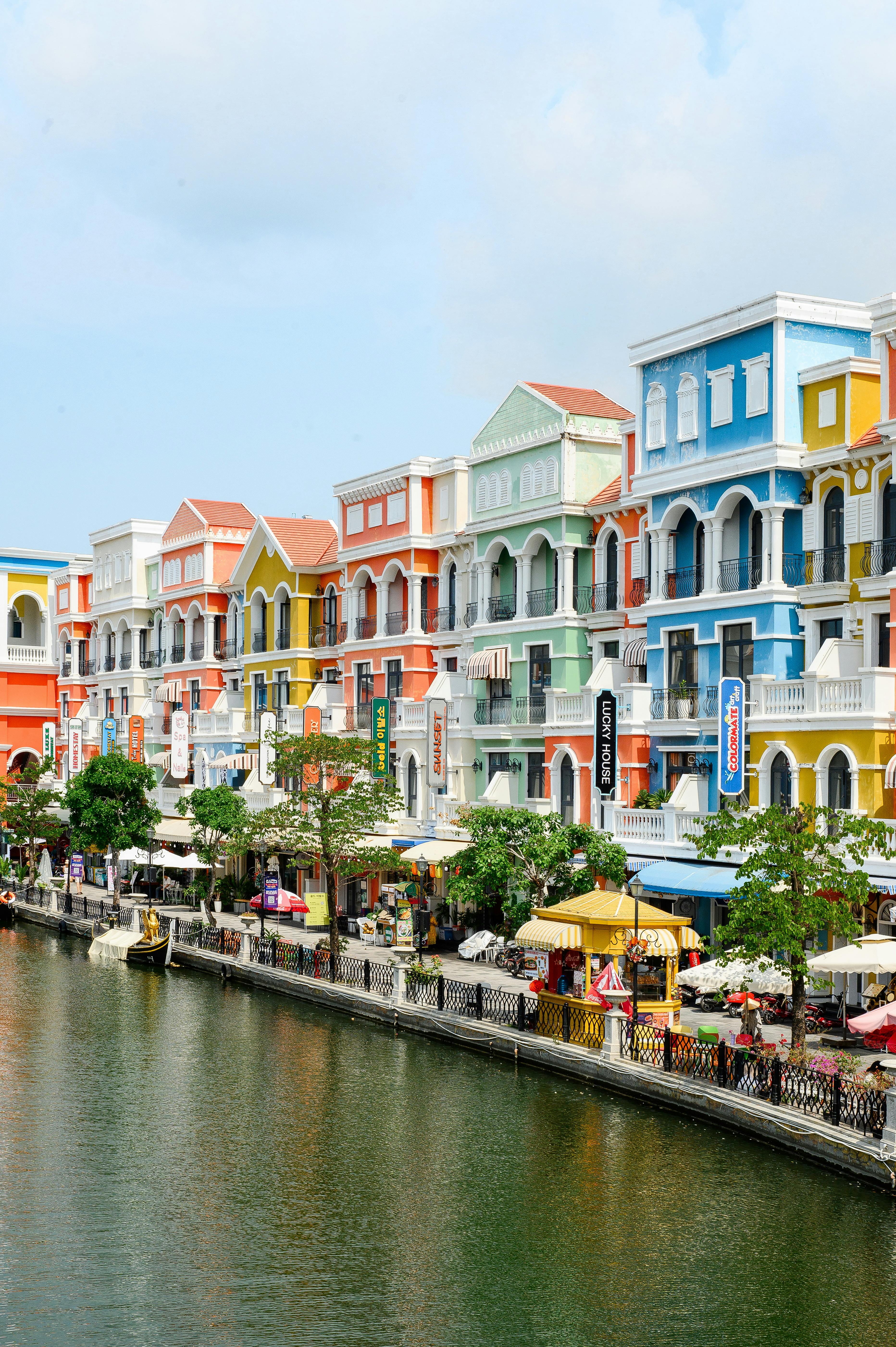 Colorful Riverside Buildings with Reflections · Free Stock Photo