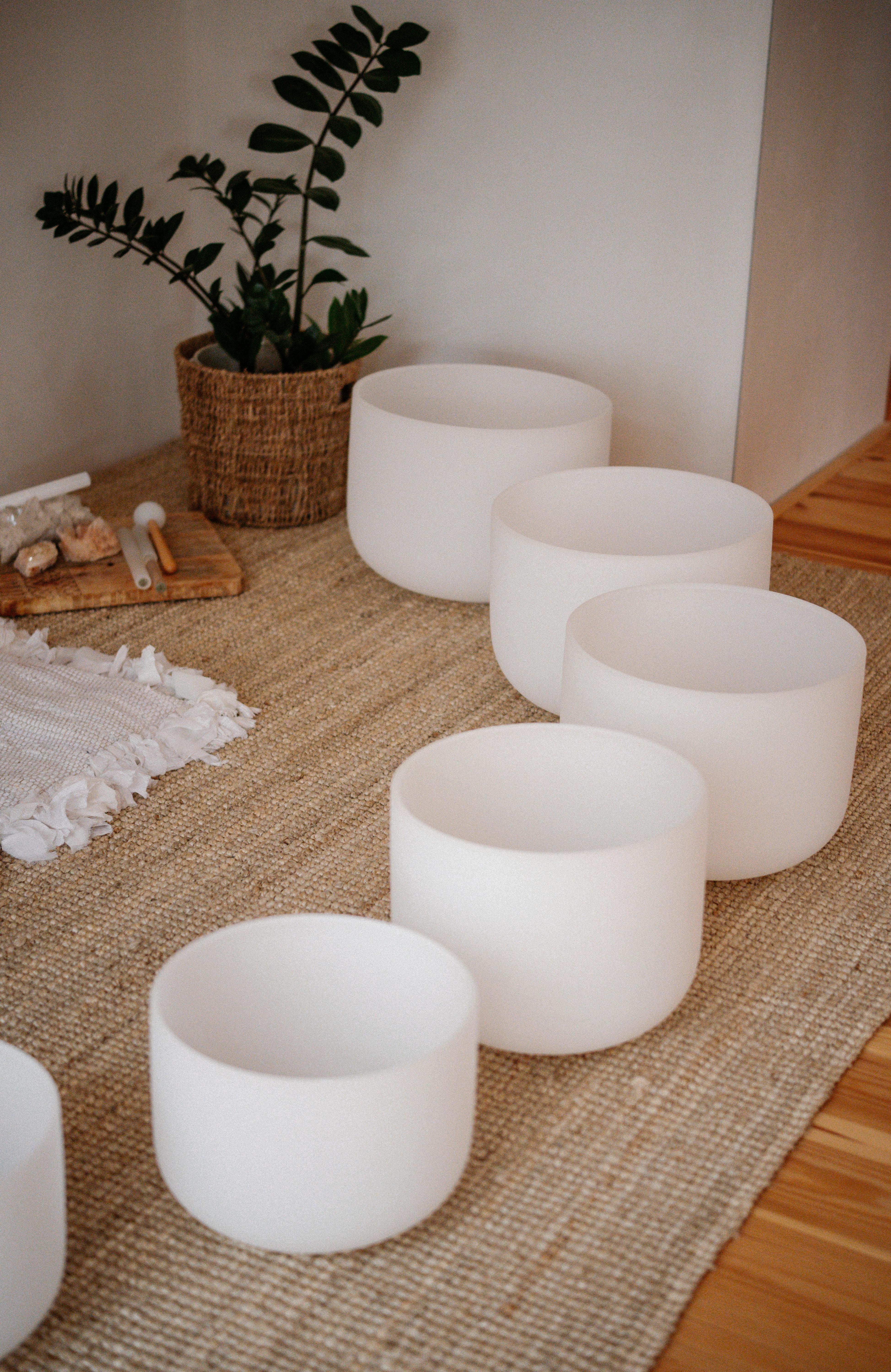 White Crystal Singing Bowls on Woven Rug · Free Stock Photo