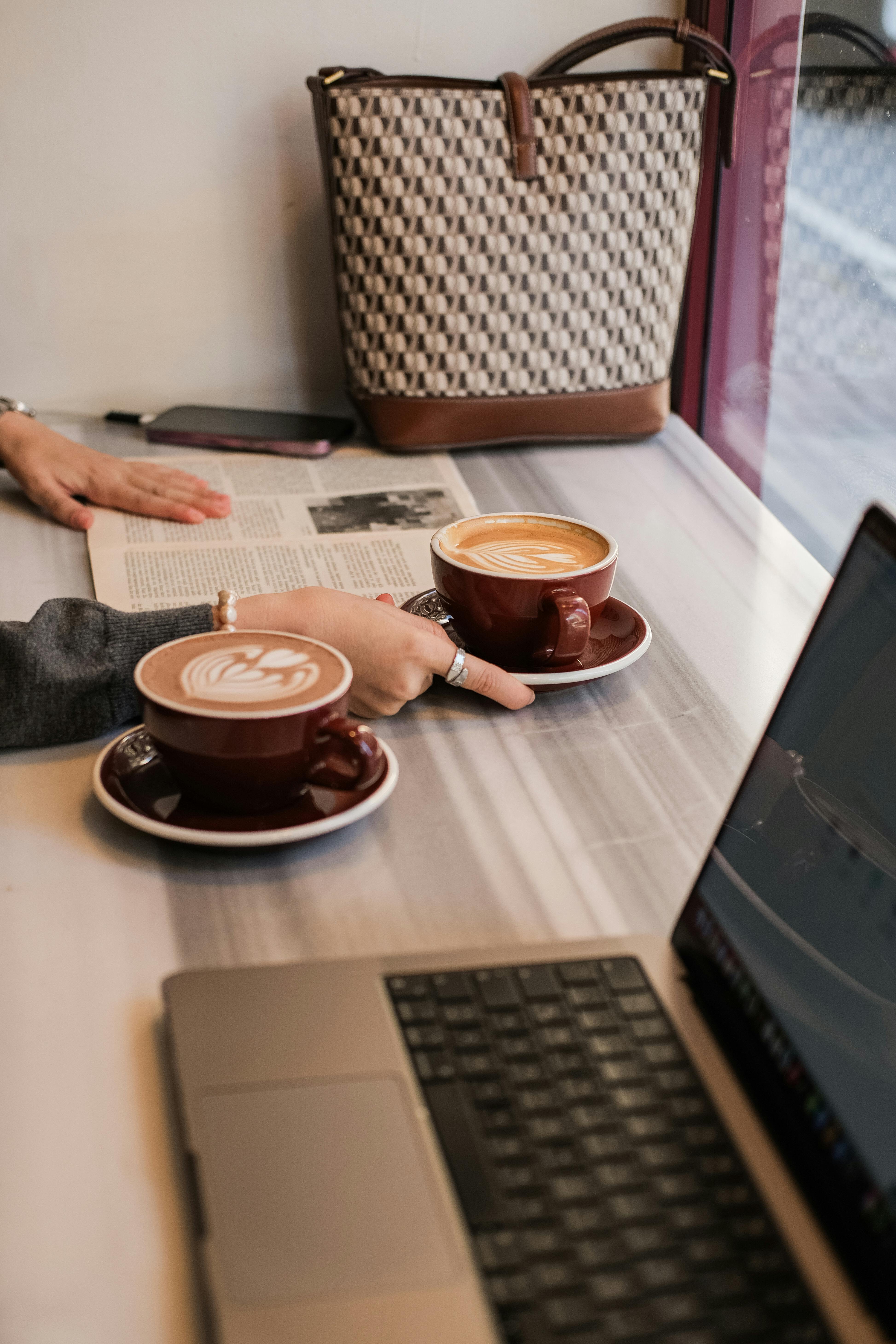Relaxed Coffee Shop Vibe with Latte Art · Free Stock Photo
