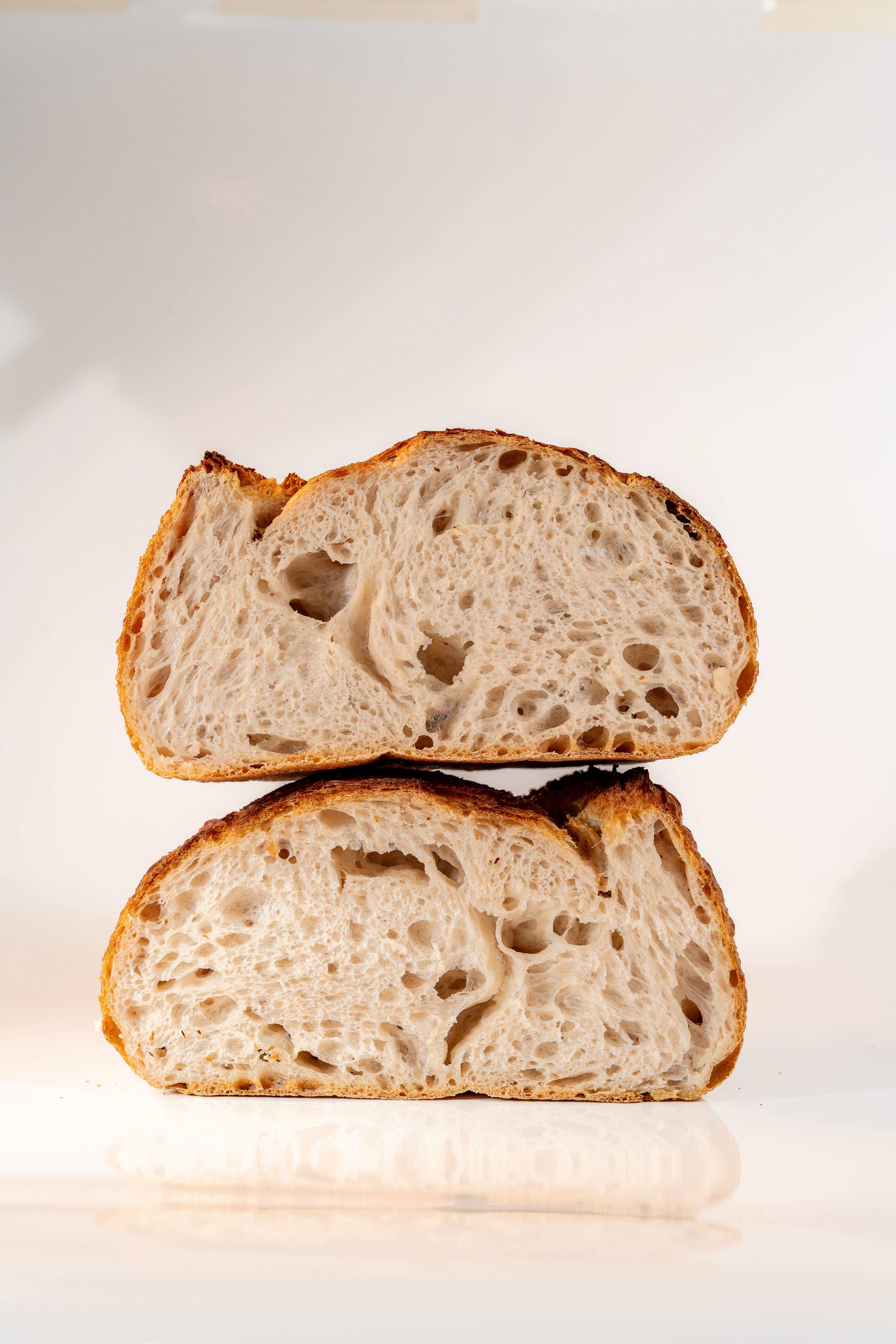 Artisan Sourdough Bread Slices on White Background · Free Stock Photo