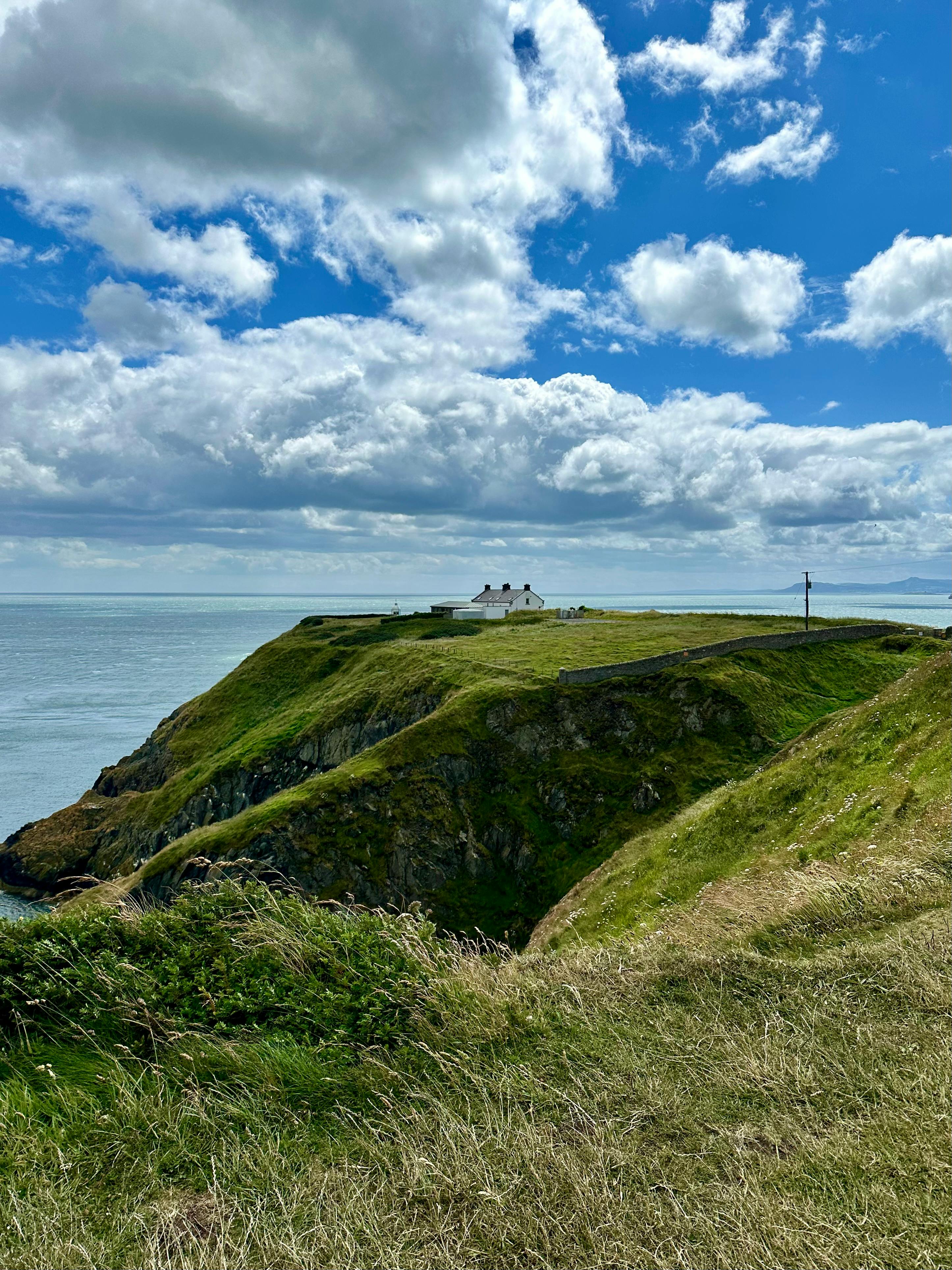 Scenic Cliffside View with Seaside Cottage · Free Stock Photo