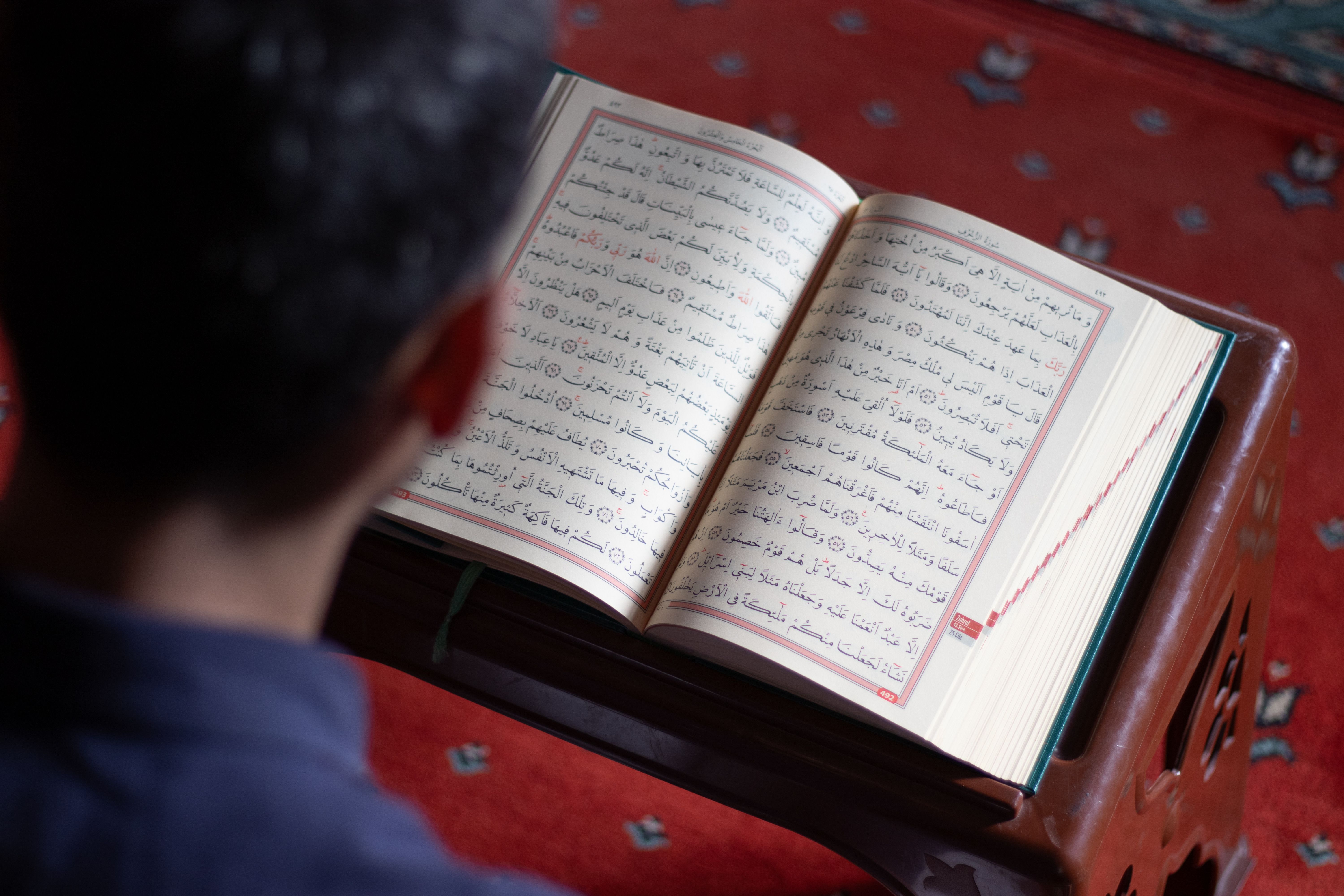 Man Reading Quran in a Mosque Interior · Free Stock Photo