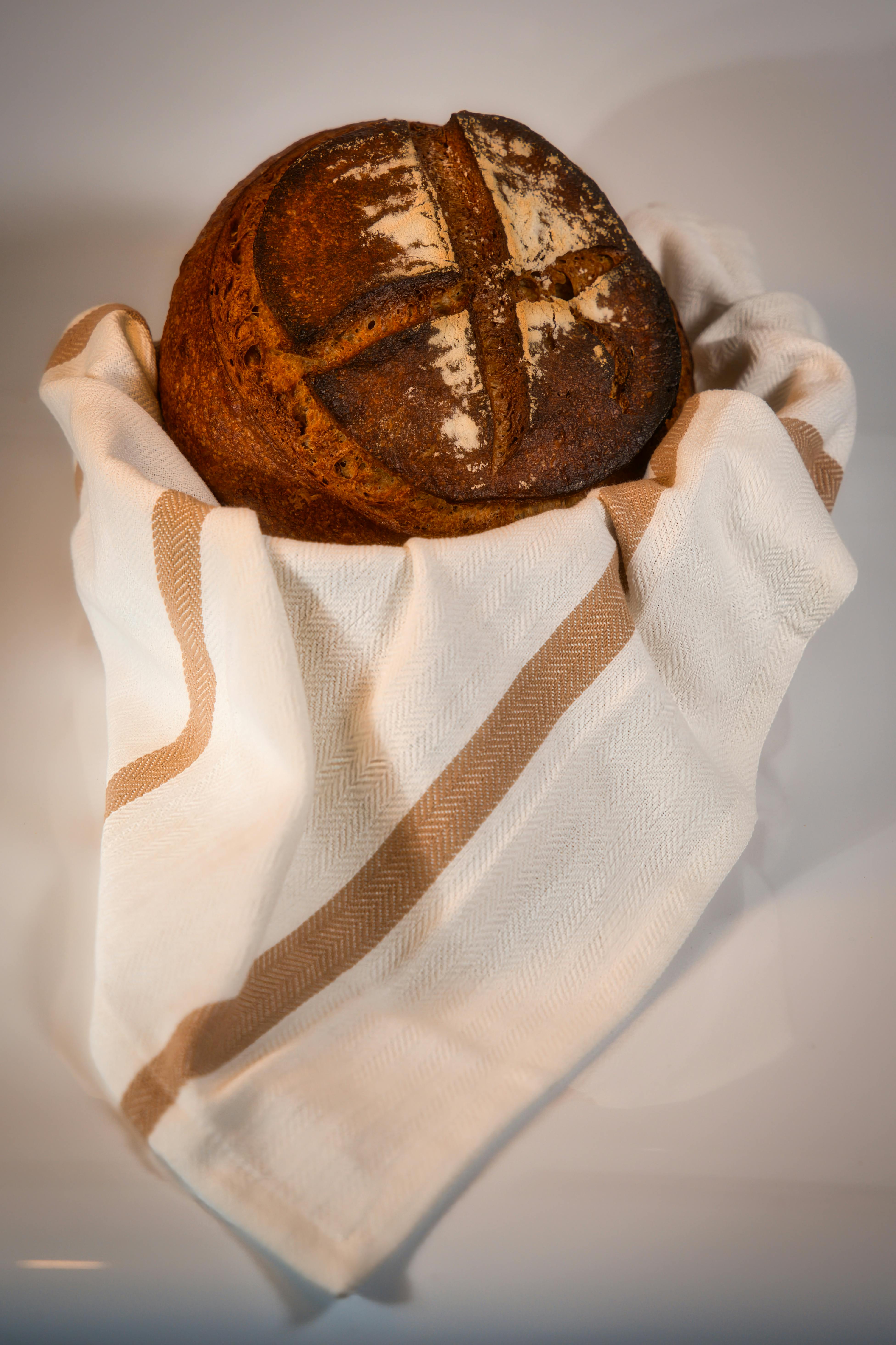 Rustic Artisan Bread Wrapped in Cloth · Free Stock Photo