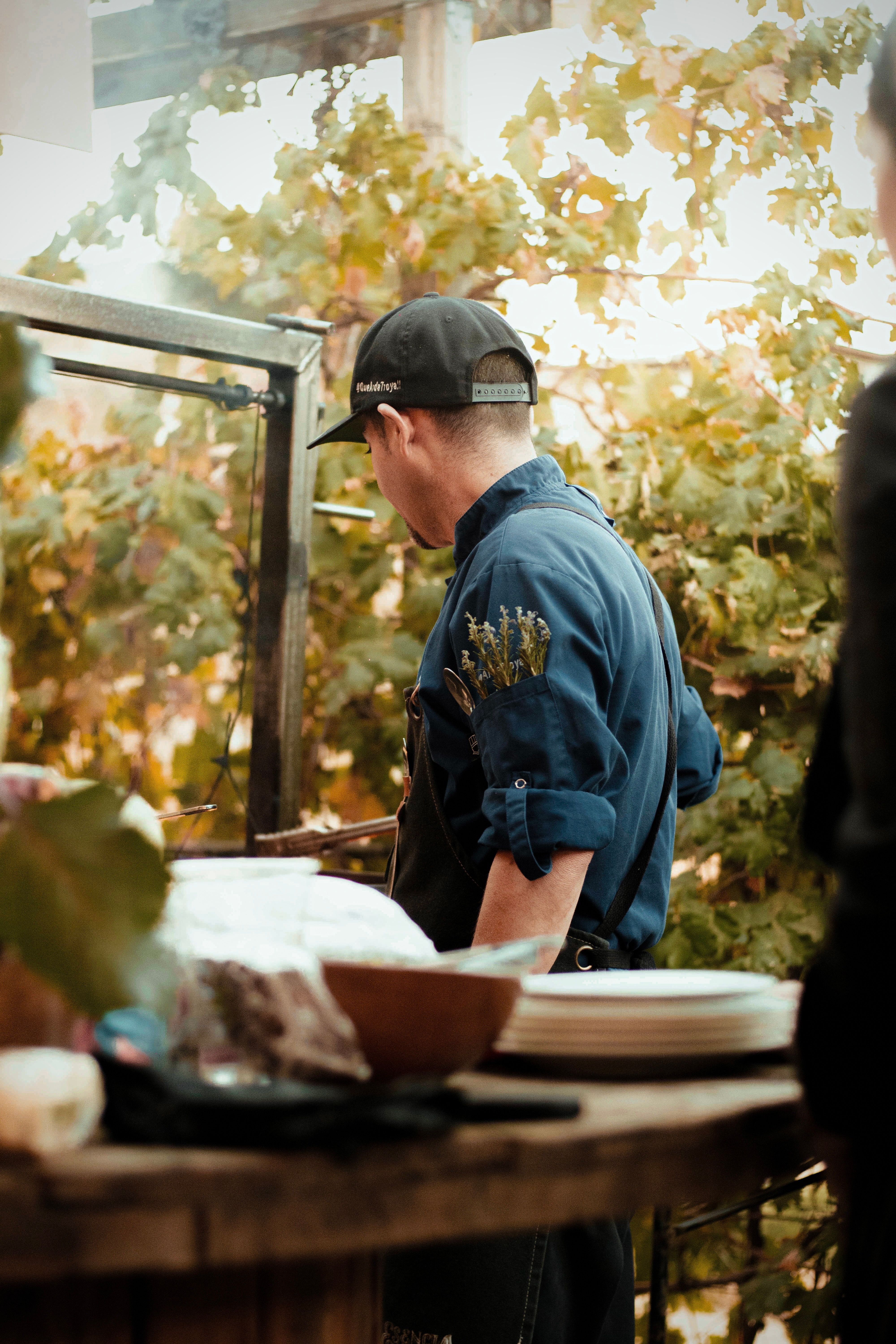Outdoor Chef Grilling in Vineyard Setting · Free Stock Photo
