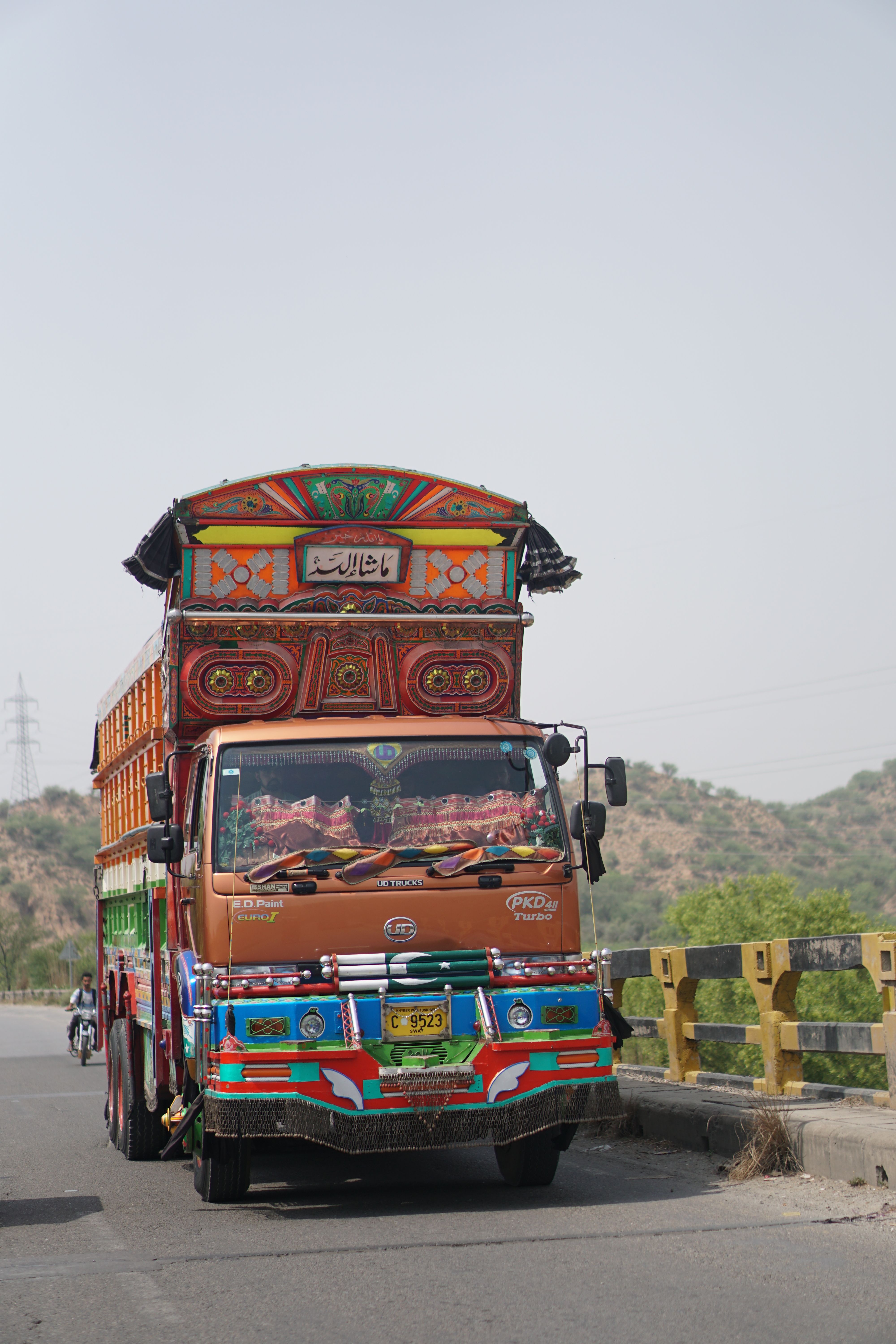 Vibrant Pakistani Truck on Scenic Highway · Free Stock Photo