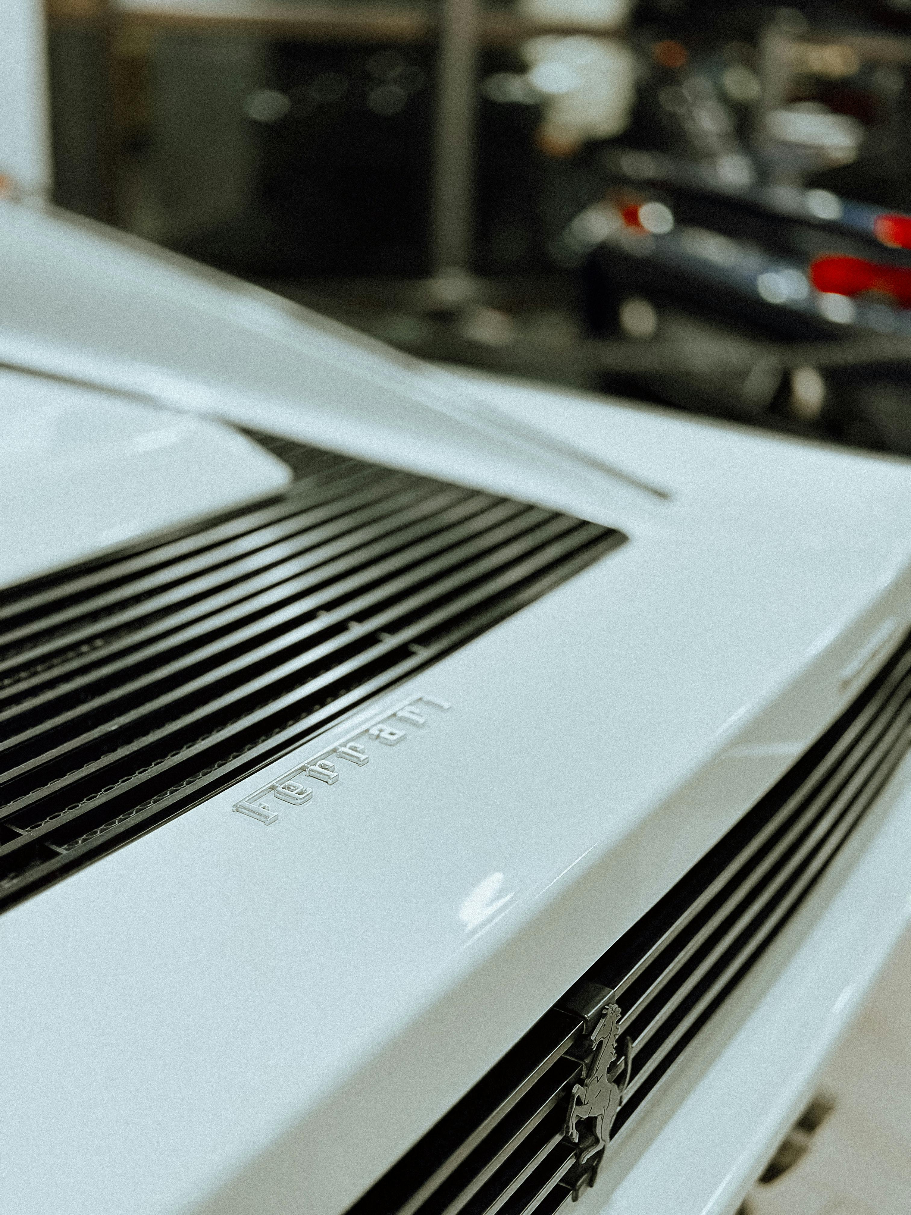Close-up of White Ferrari Rear with Logo Emphasis · Free Stock Photo