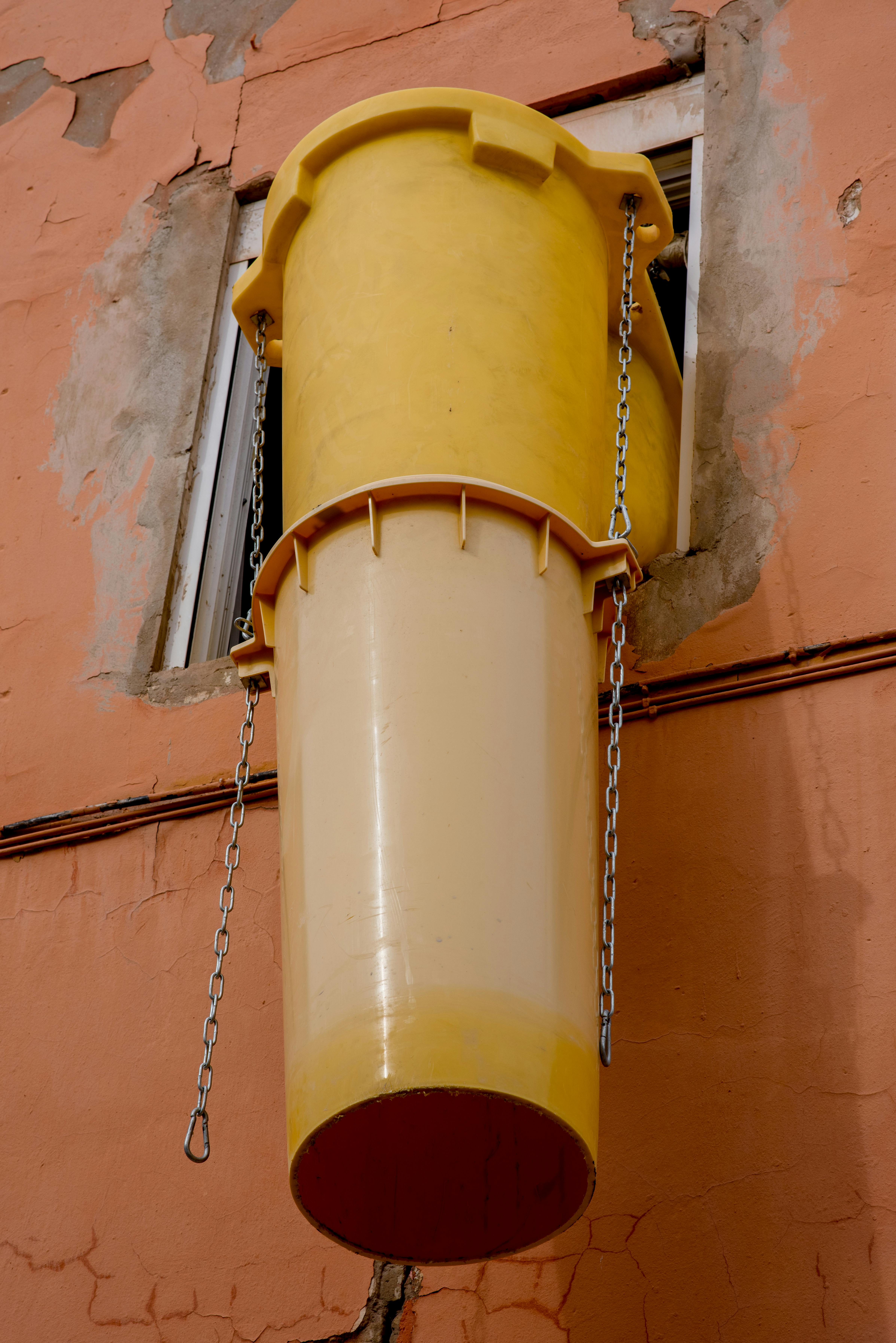 Bright Yellow Construction Waste Chute Outdoors · Free Stock Photo