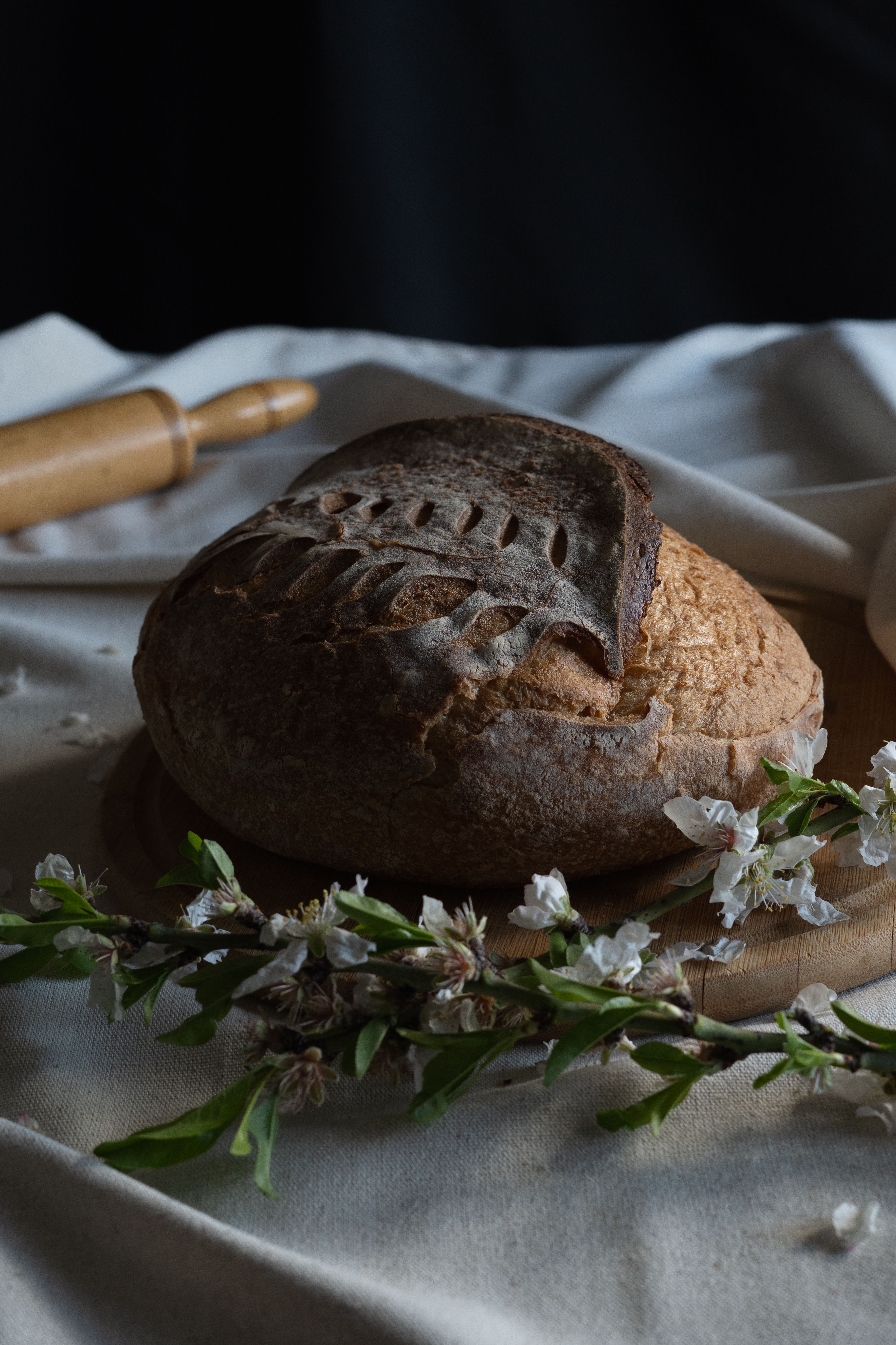 Rustic Artisan Bread with Floral Decor on Table · Free Stock Photo