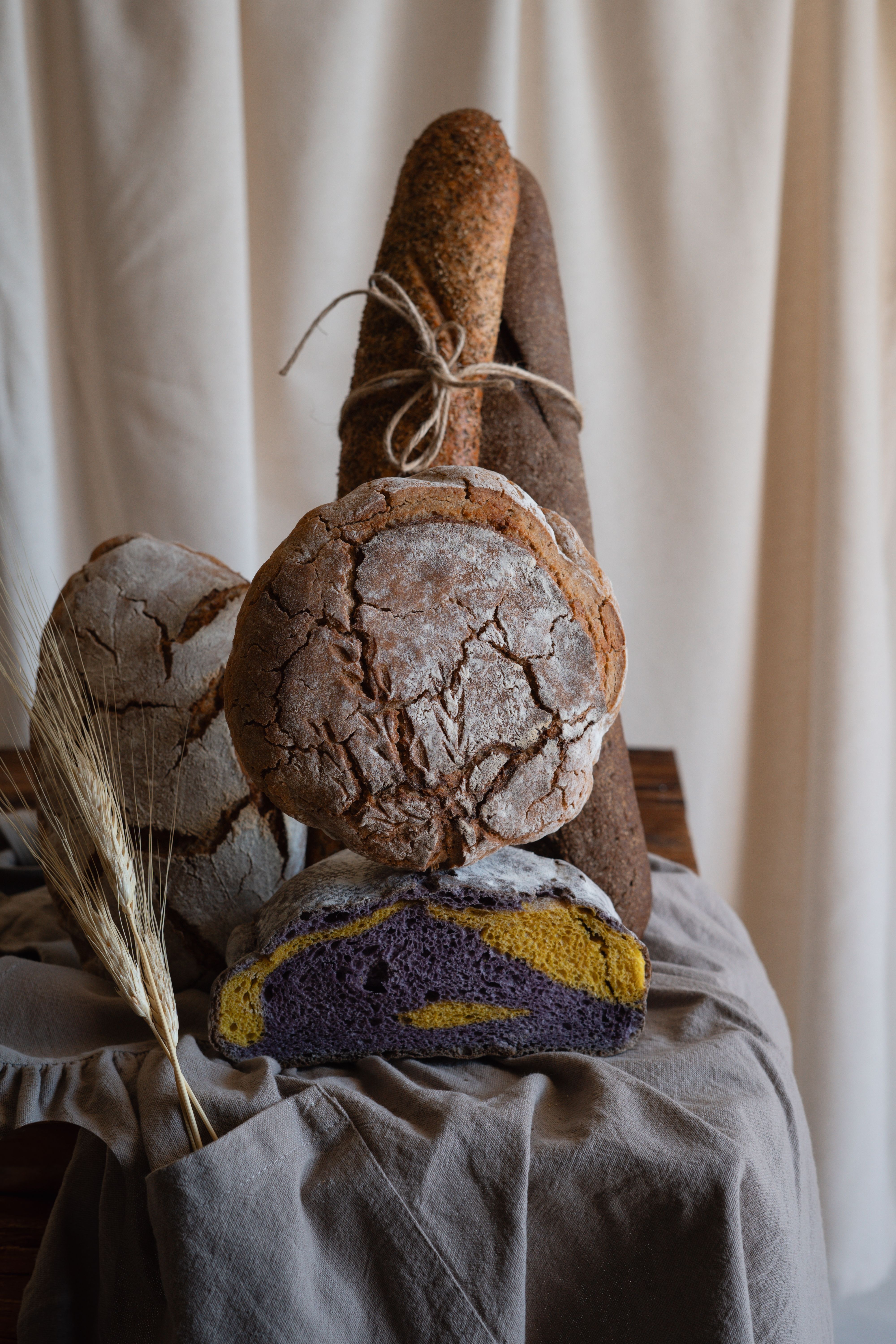 Rustic Artisan Bread Display in Cozy Setting · Free Stock Photo
