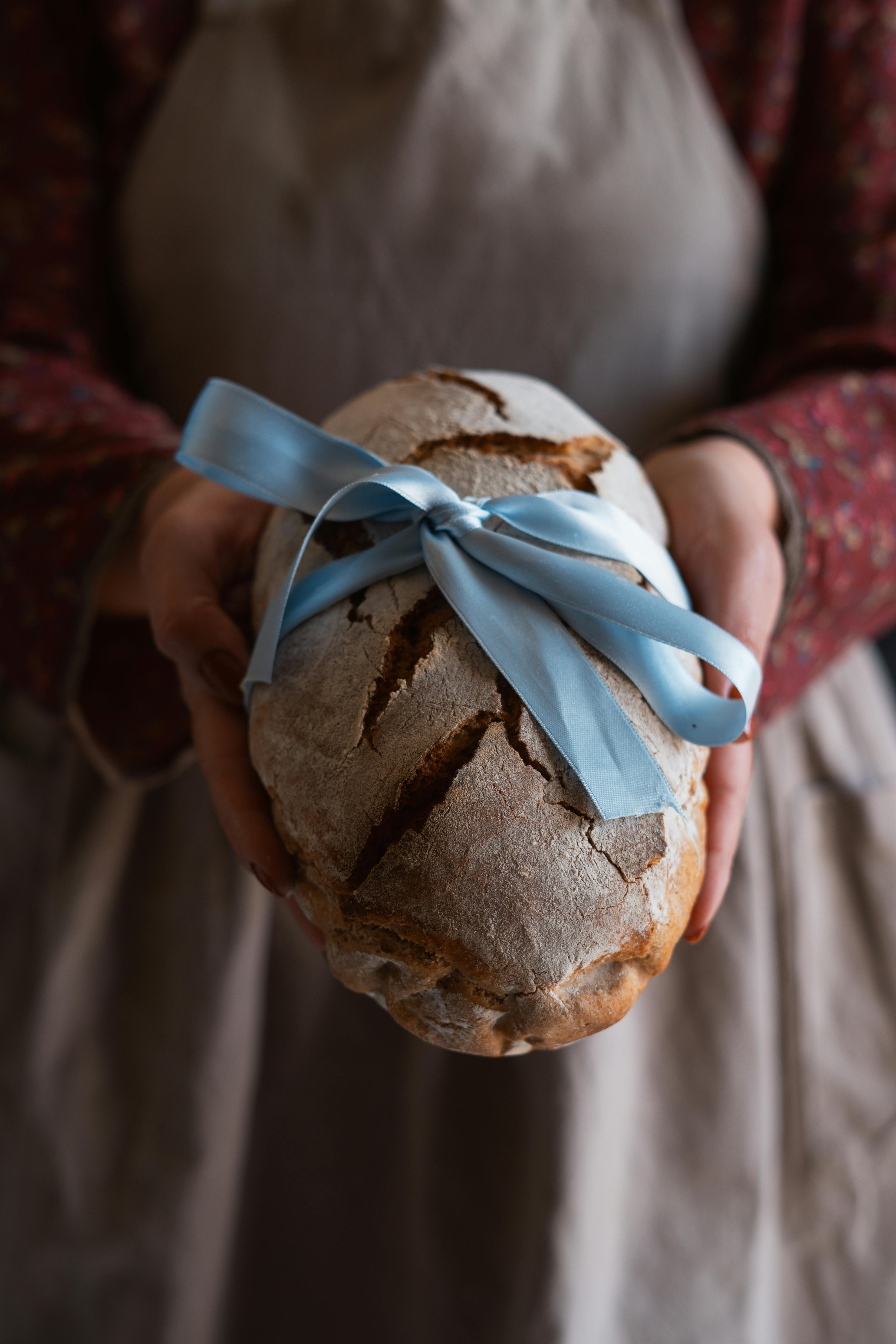 Artisan Bread Loaf Wrapped in Blue Ribbon · Free Stock Photo