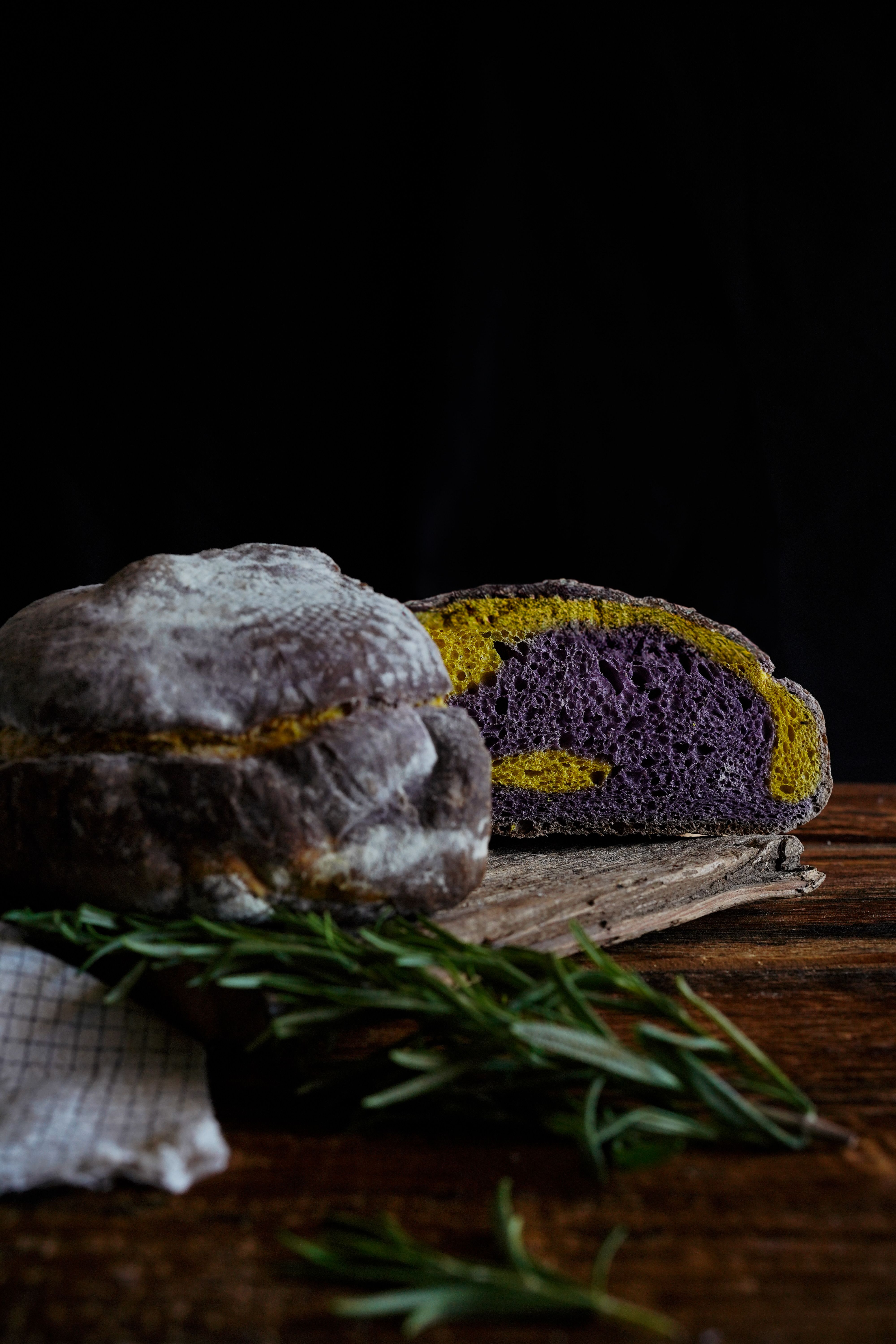 Artisan Multicolor Bread with Herbs on Rustic Table · Free Stock Photo