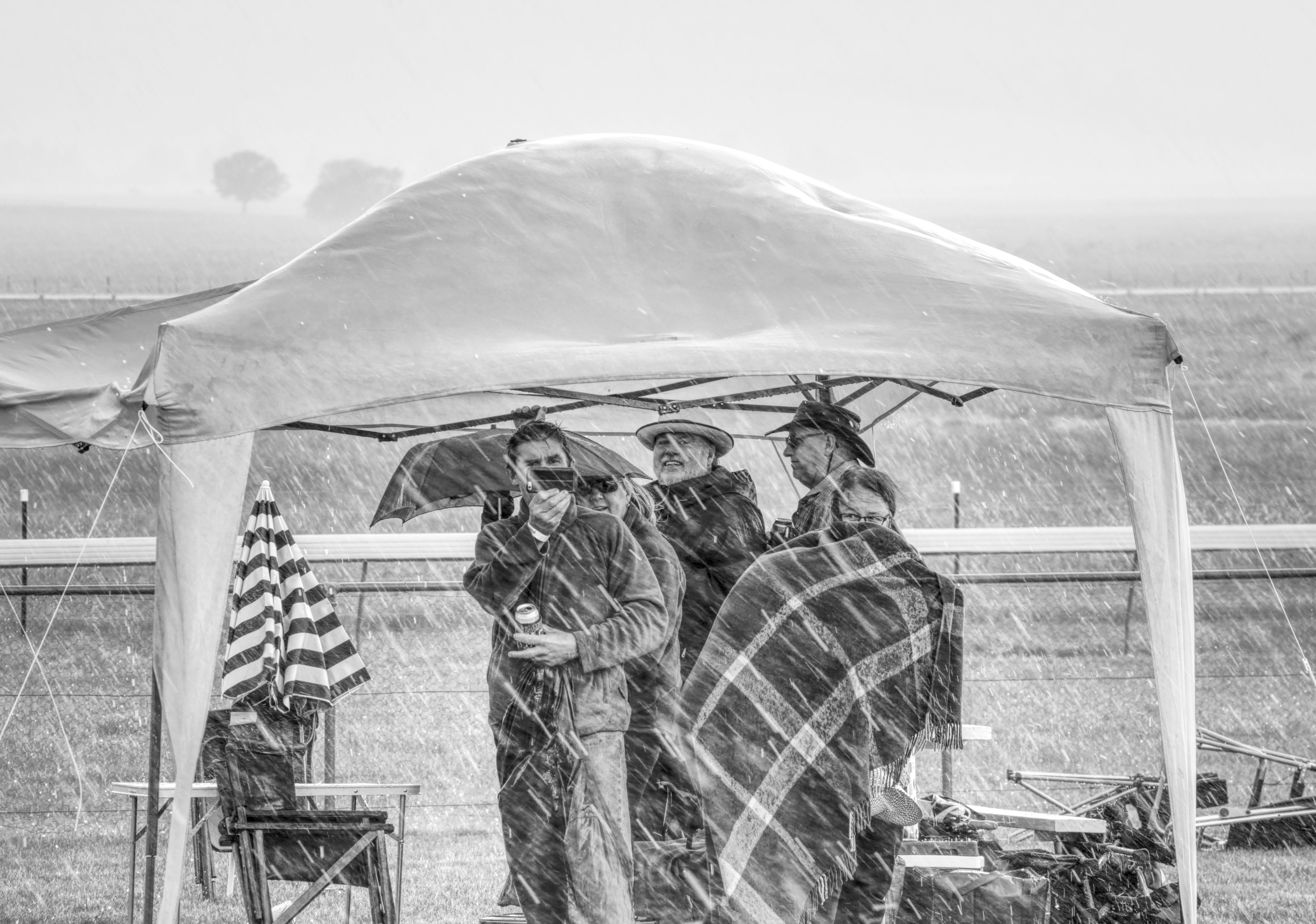People Sheltering from Rain Under a Tent · Free Stock Photo