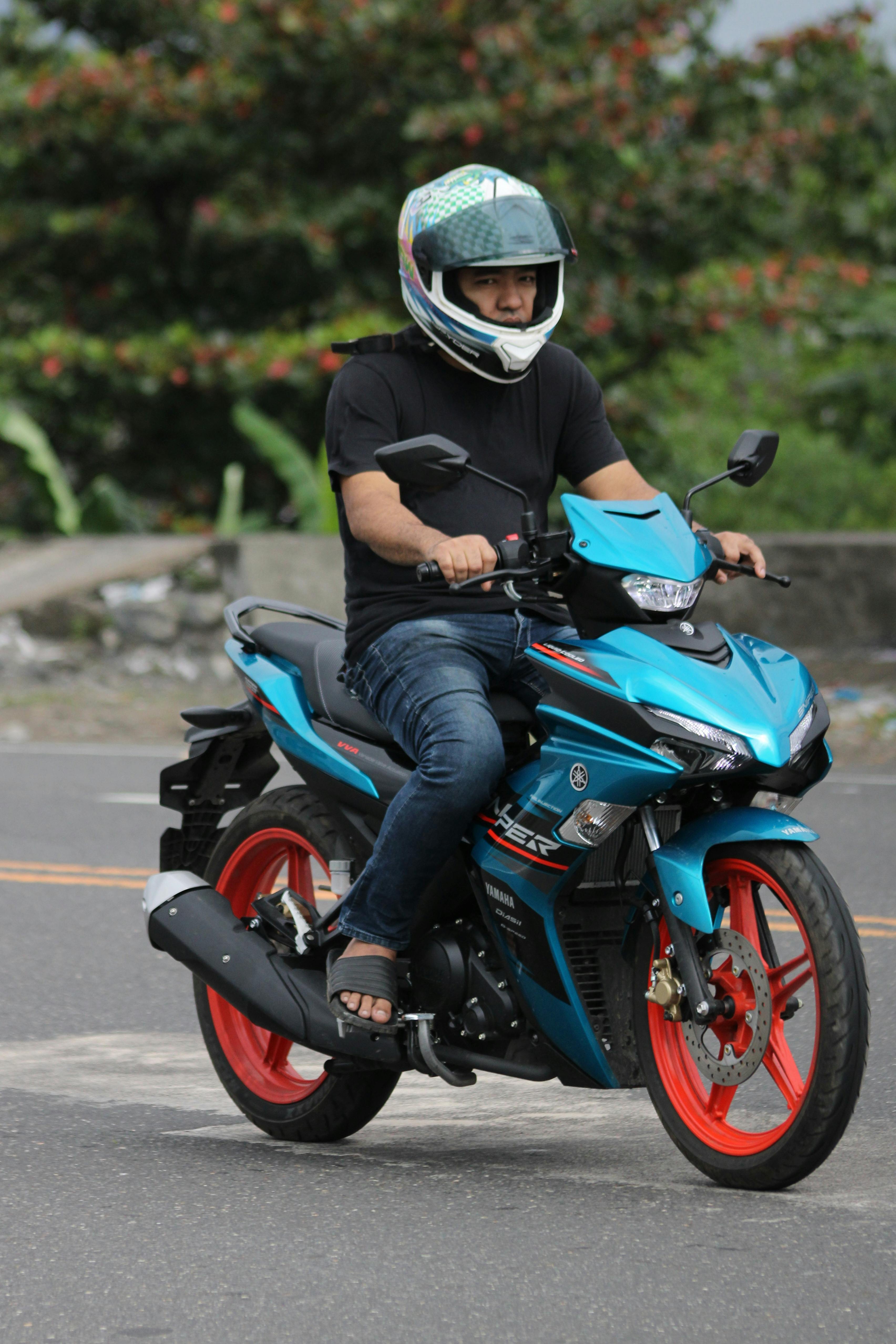 Man Riding Blue Motorcycle on a Sunny Street · Free Stock Photo