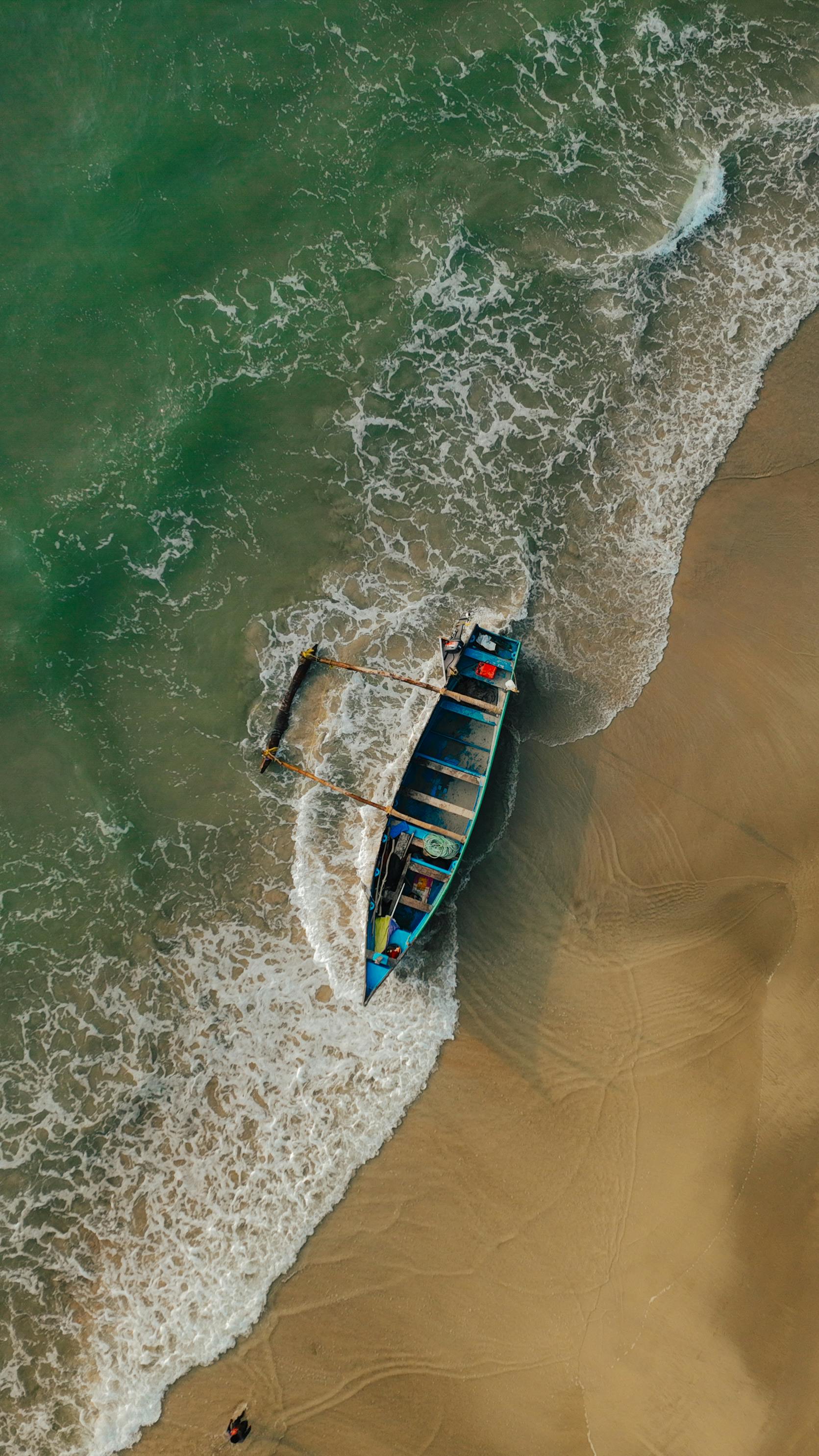 Aerial View of Fishing Boat on Sandy Beach · Free Stock Photo