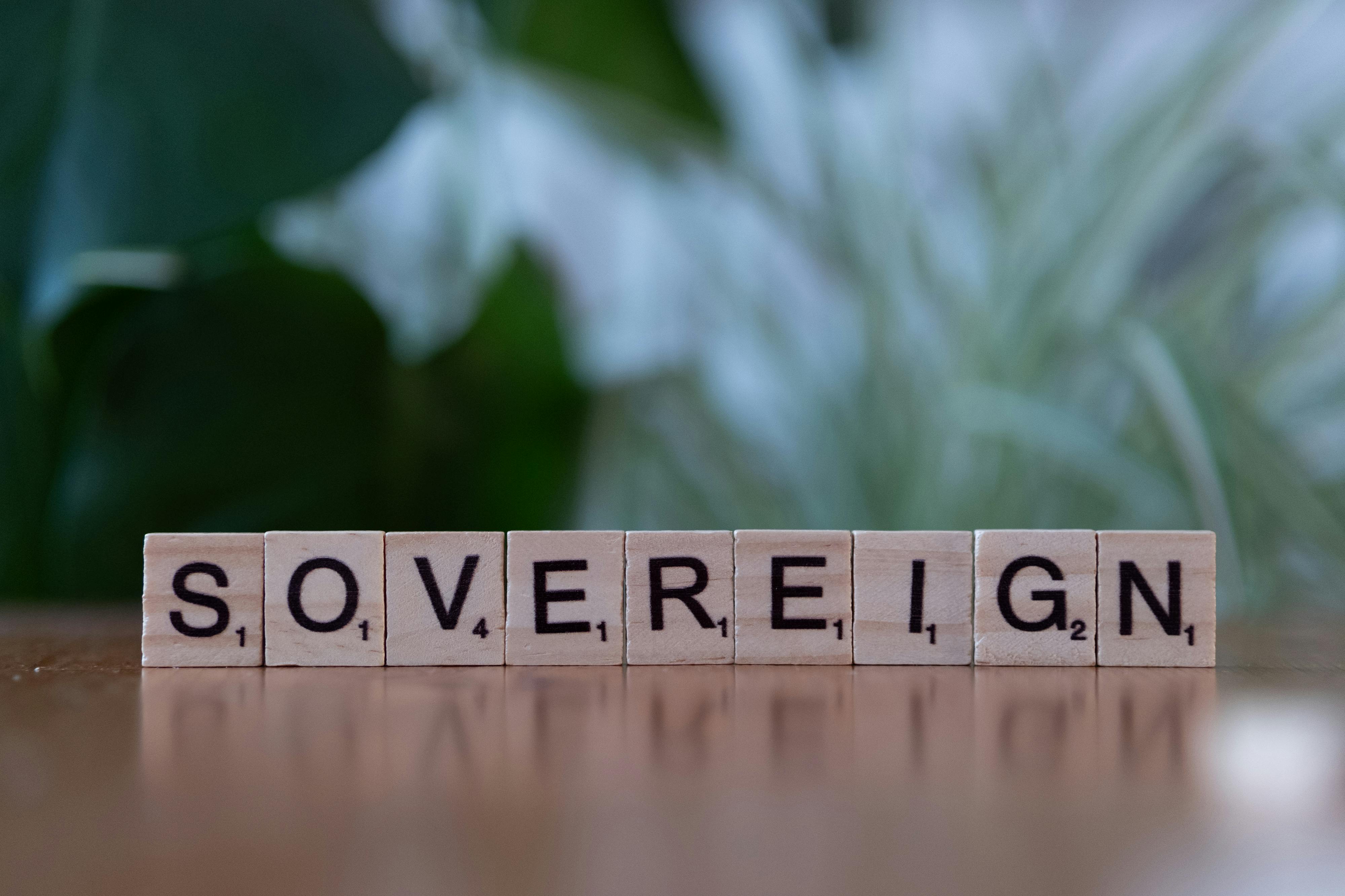 Sovereign Word in Scrabble Tiles on Wooden Table · Free Stock Photo