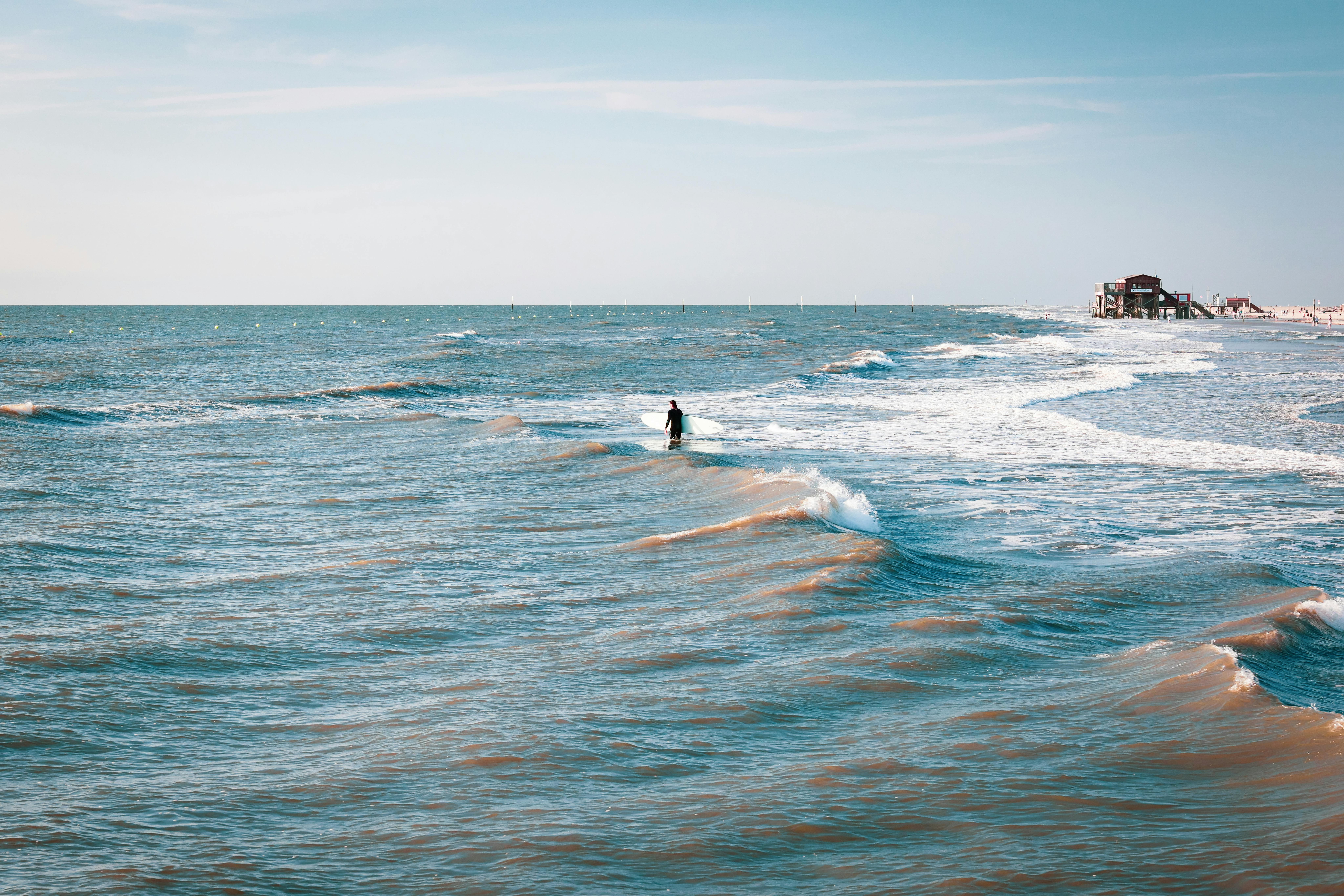 Surfer Riding the Waves at Sankt Peter-Ording · Free Stock Photo