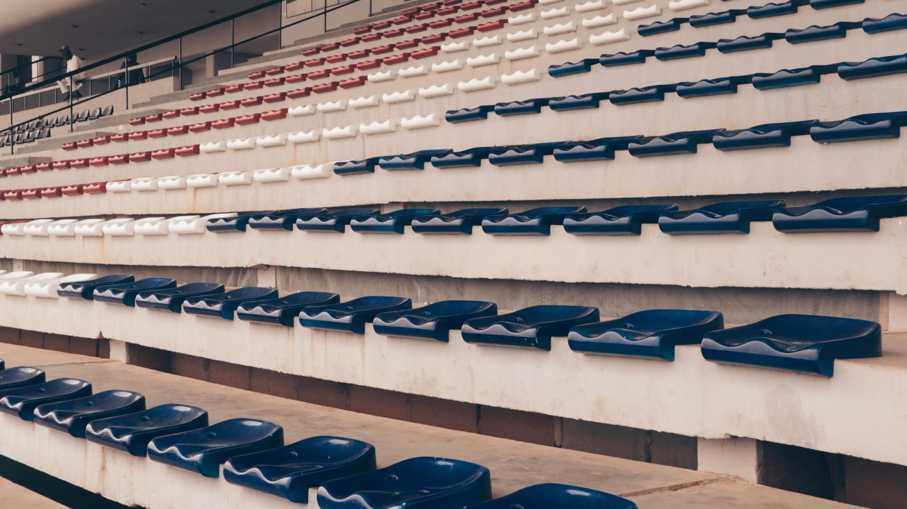 Empty Stadium Seating with Tricolor Arrangement · Free Stock Photo