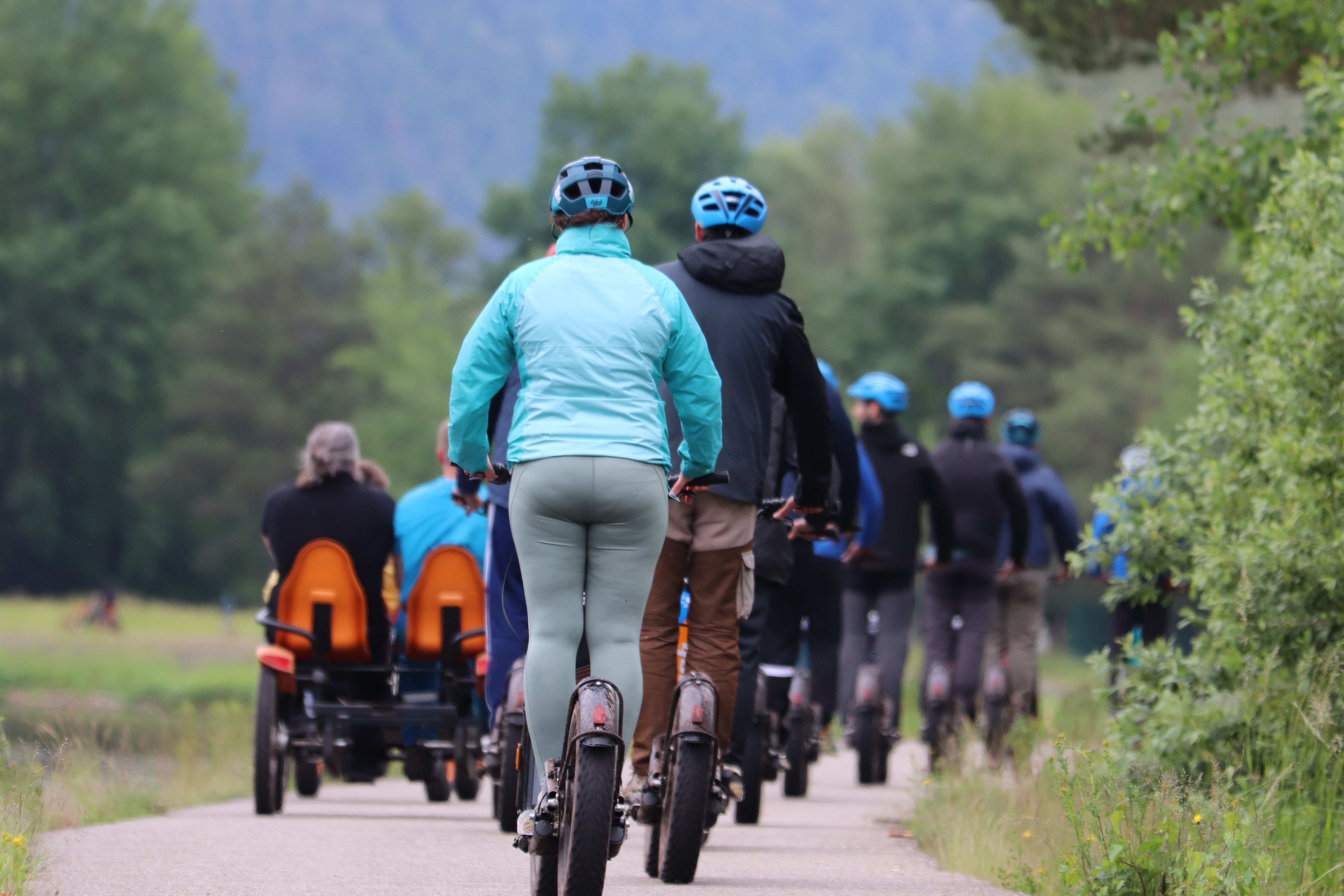 Group Riding Electric Scooters in Scenic Nature Setting · Free Stock Photo