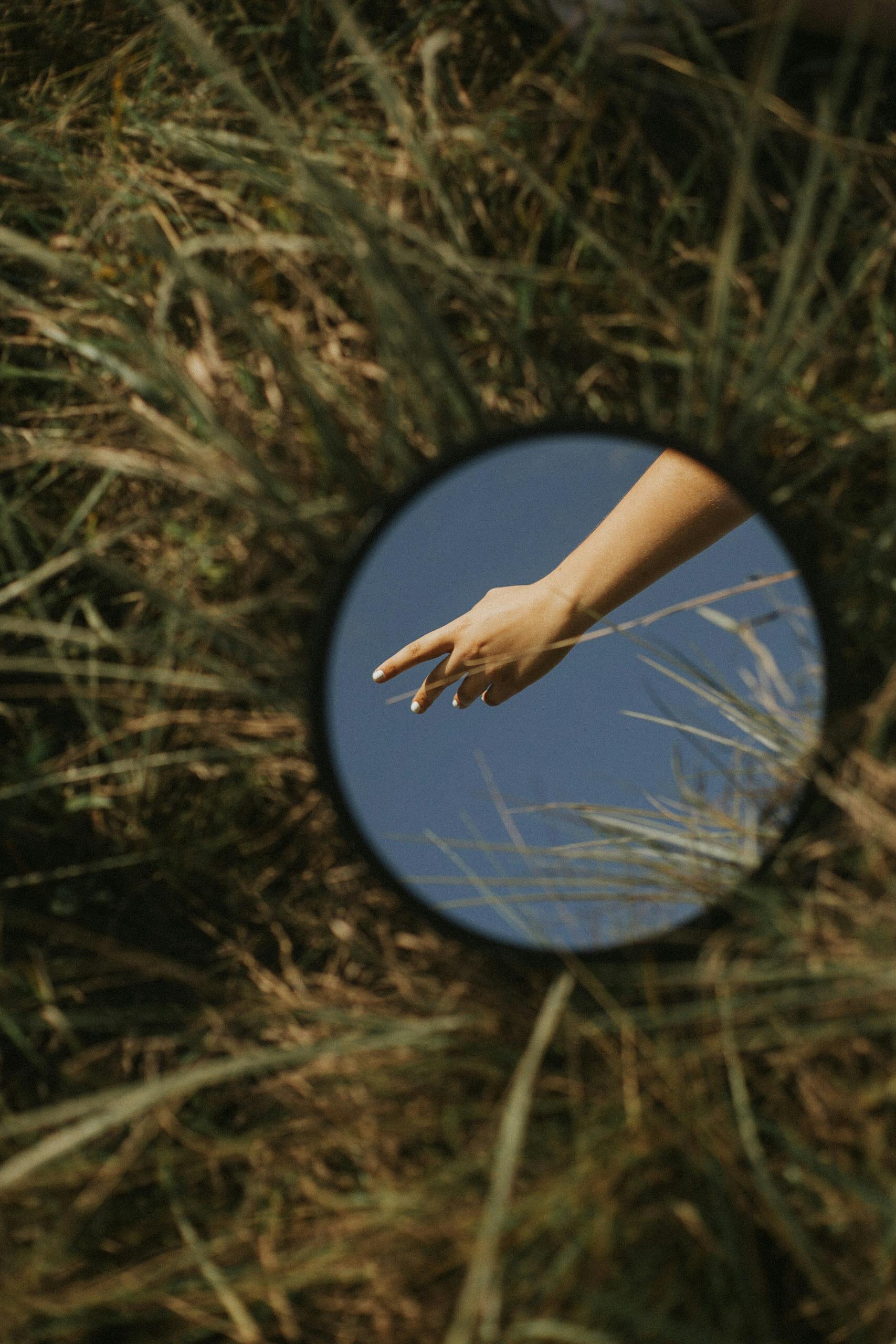 Reflective Nature Scene with Outstretched Hand · Free Stock Photo