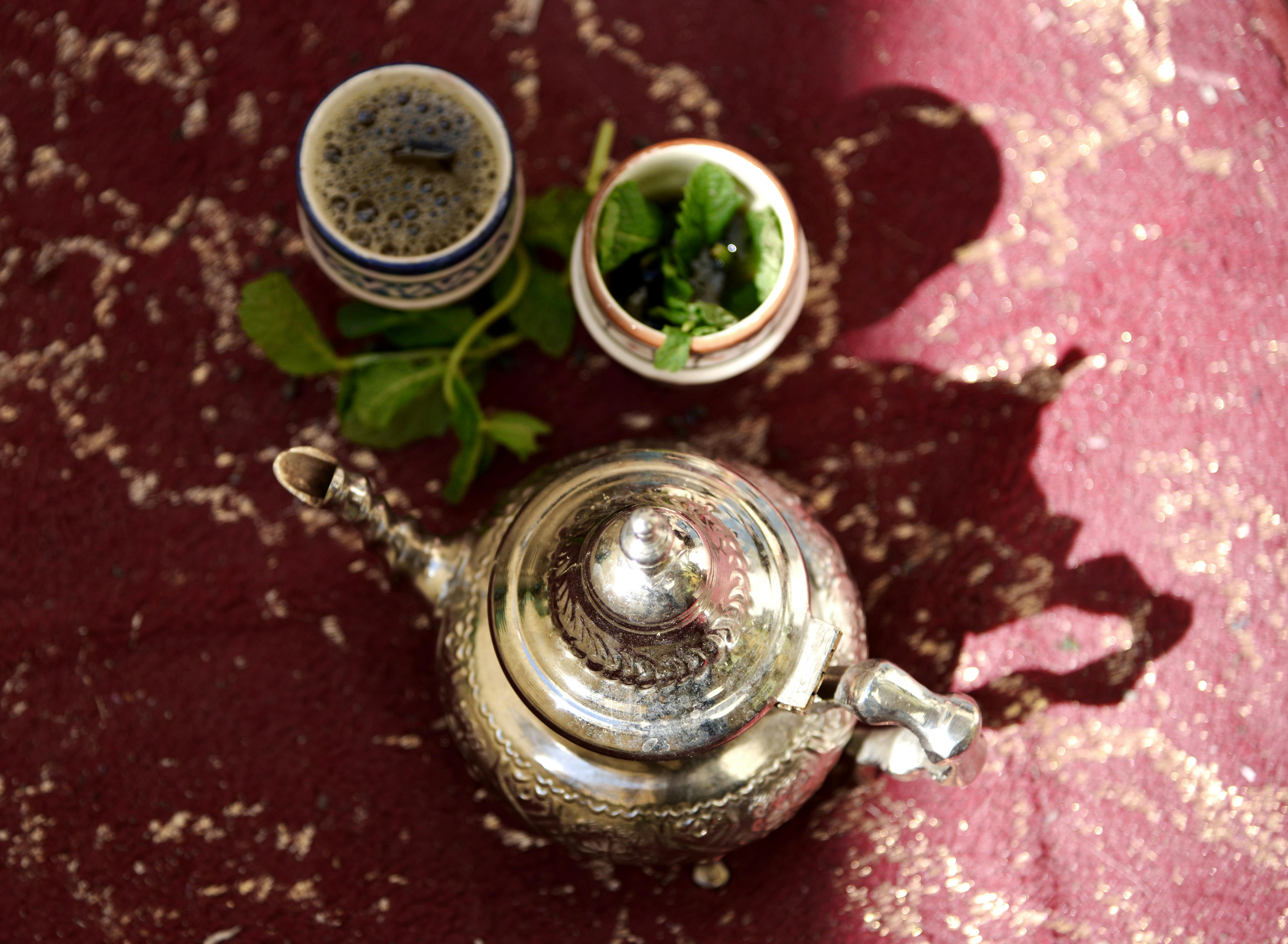 Traditional Moroccan Mint Tea Set on Ornate Carpet · Free Stock Photo