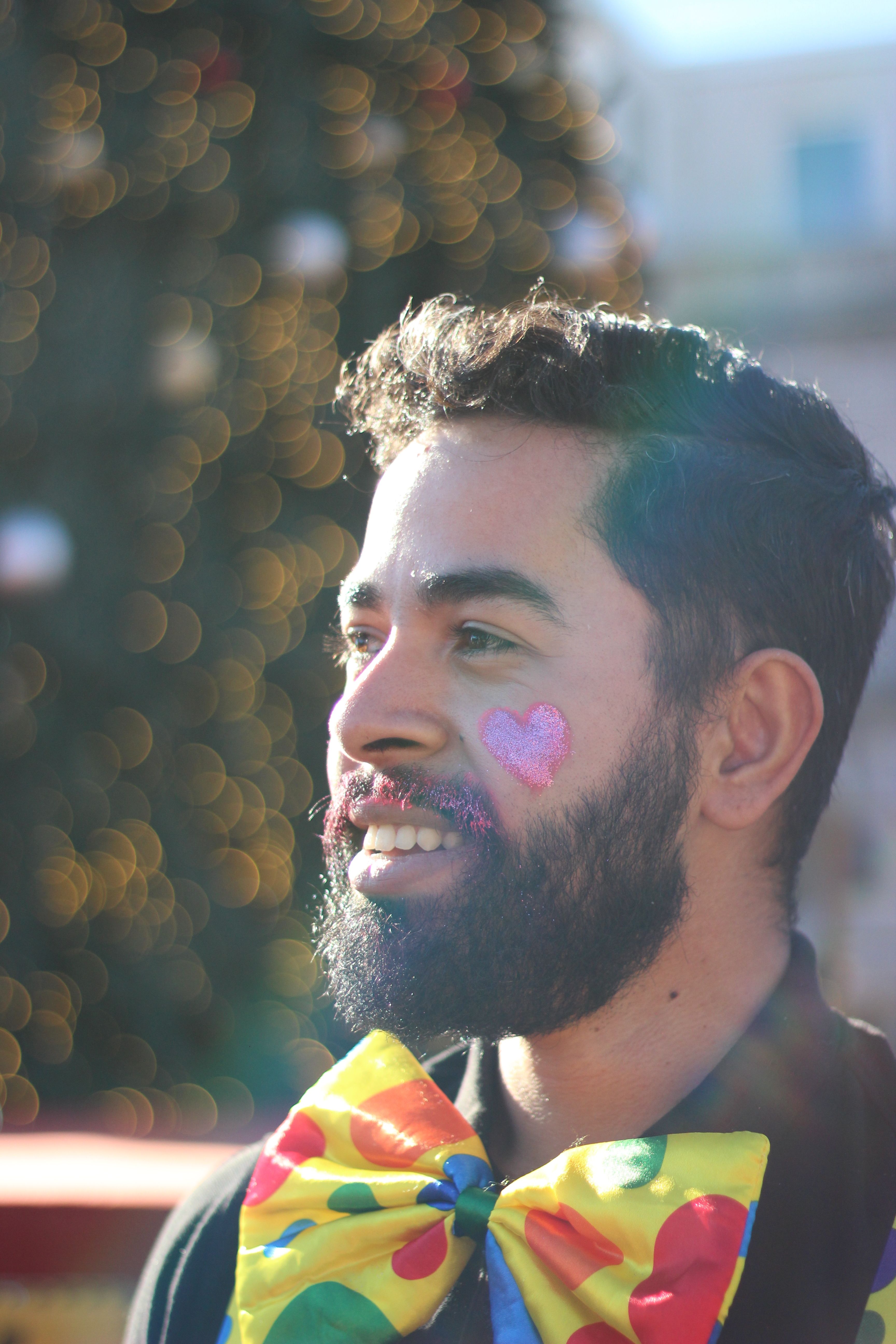 Joyful Man with Face Paint and Bow Tie in Festive Setting · Free Stock ...