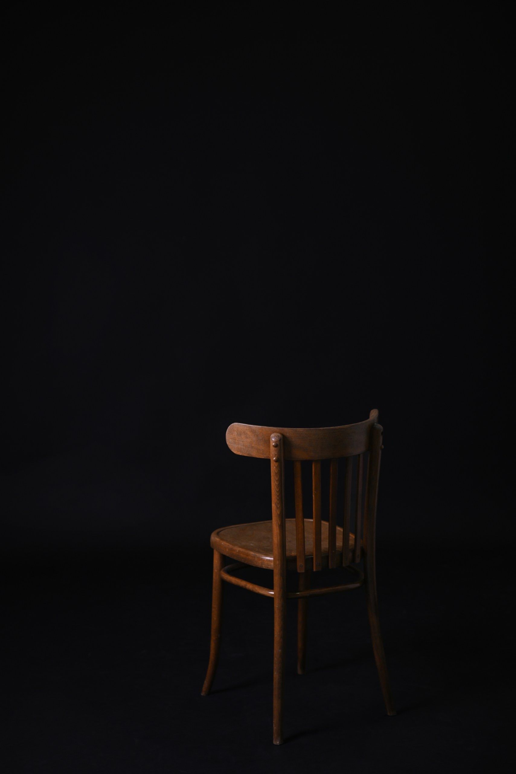Minimalist Wooden Chair in Dark Studio Setting · Free Stock Photo