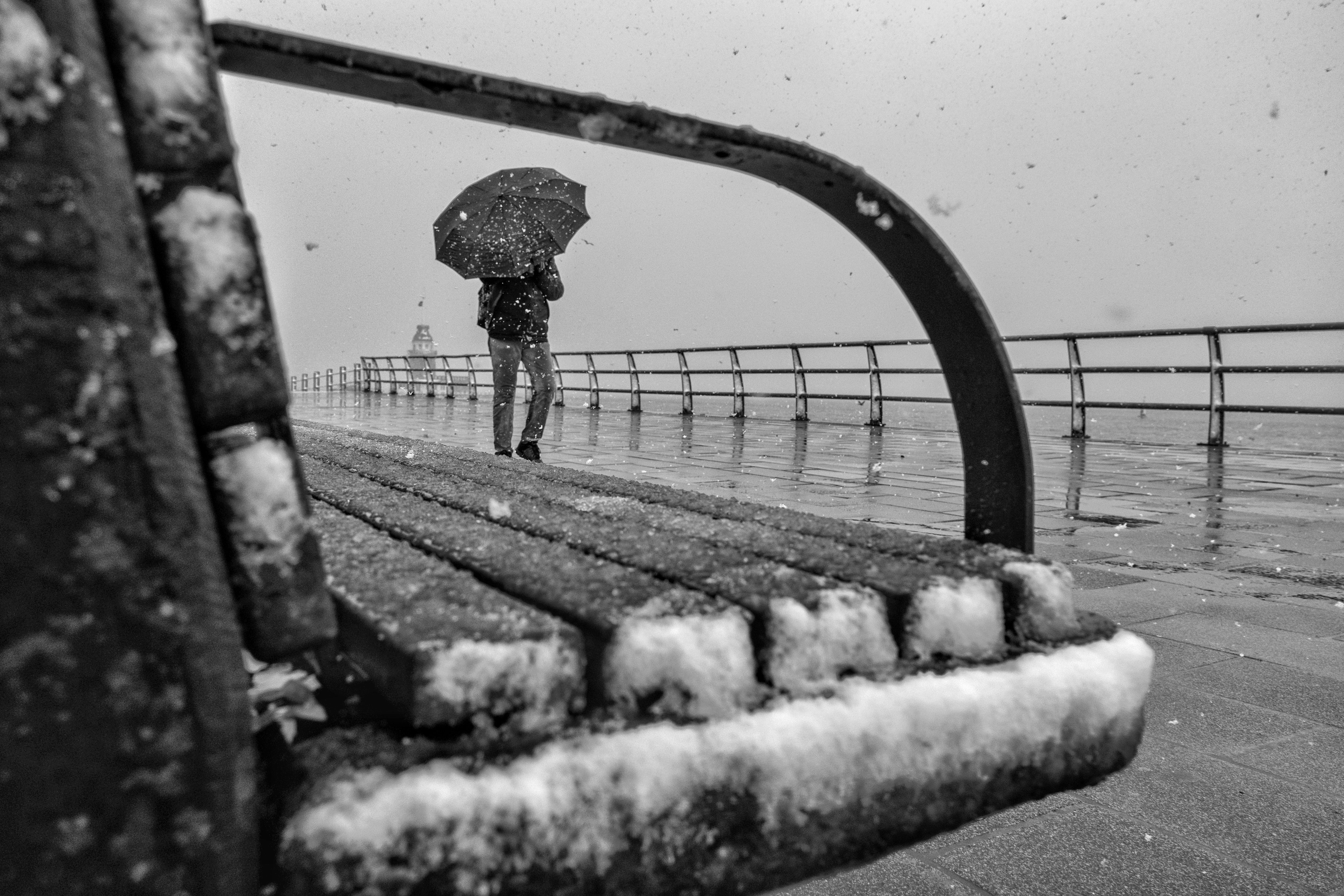 Moody Winter Scene with Umbrella on Snowy Boardwalk · Free Stock Photo