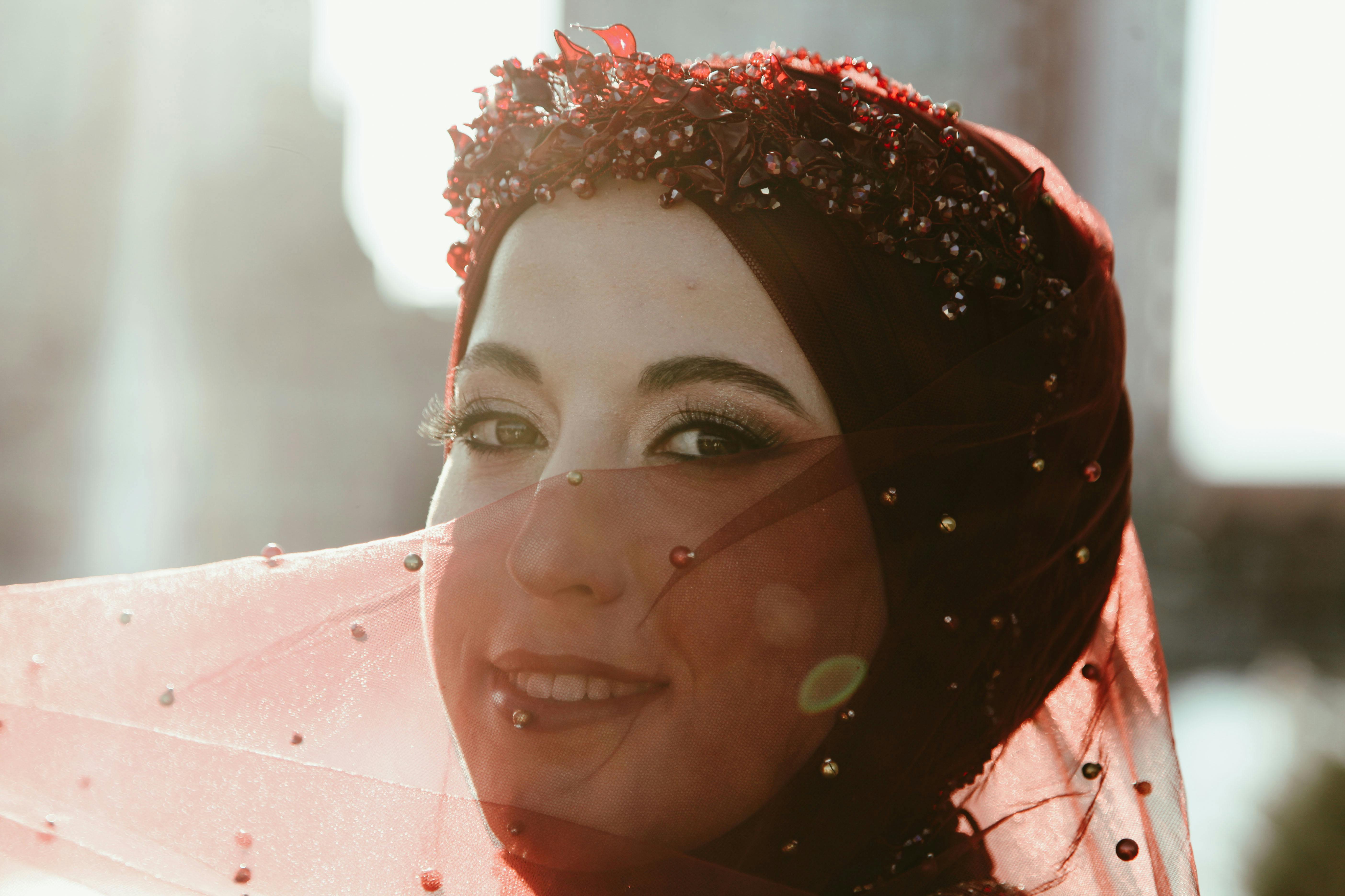 Elegant Portrait of Smiling Woman in Red Veil · Free Stock Photo