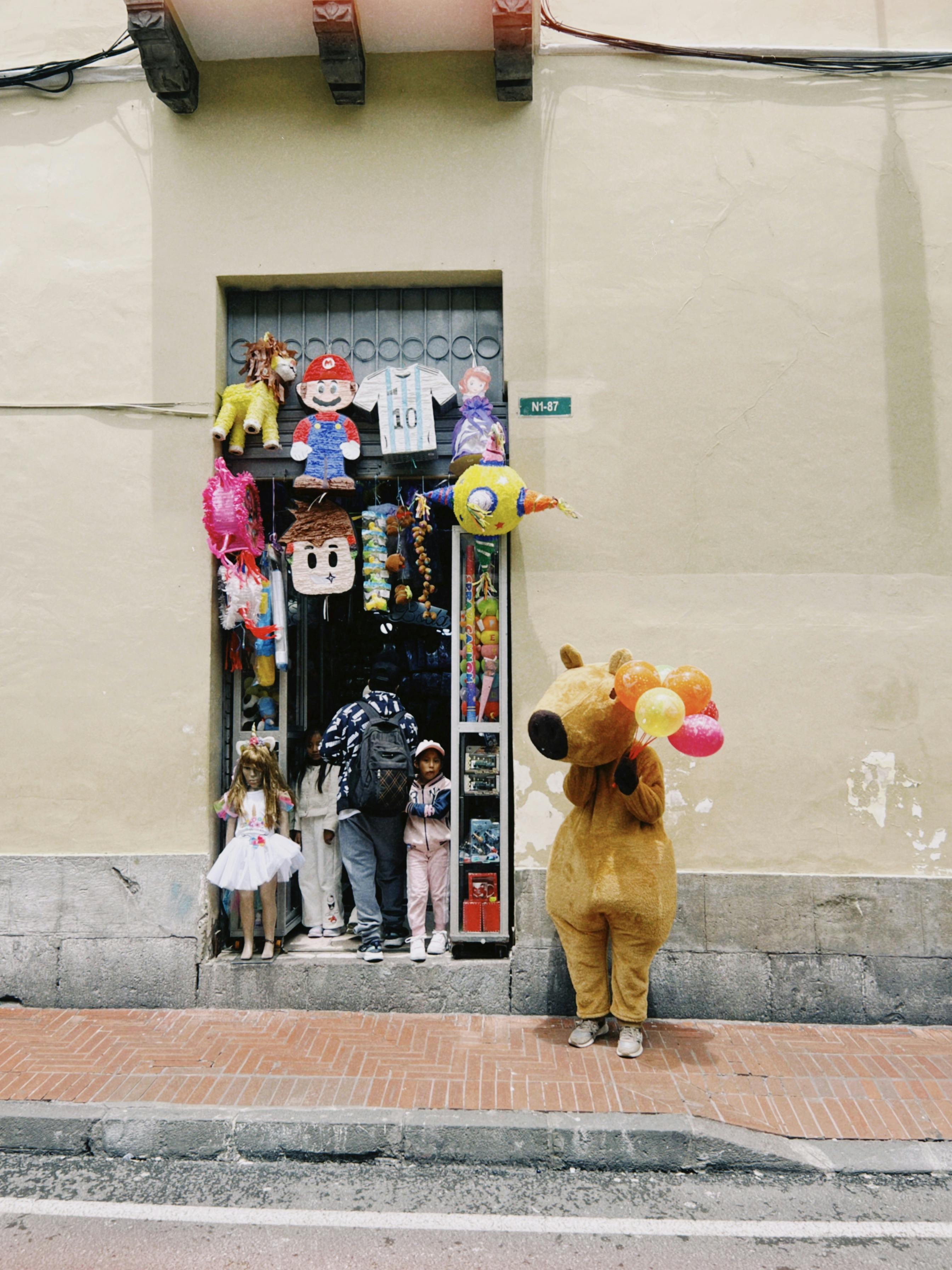 Colorful Toy Storefront with Costumed Character · Free Stock Photo