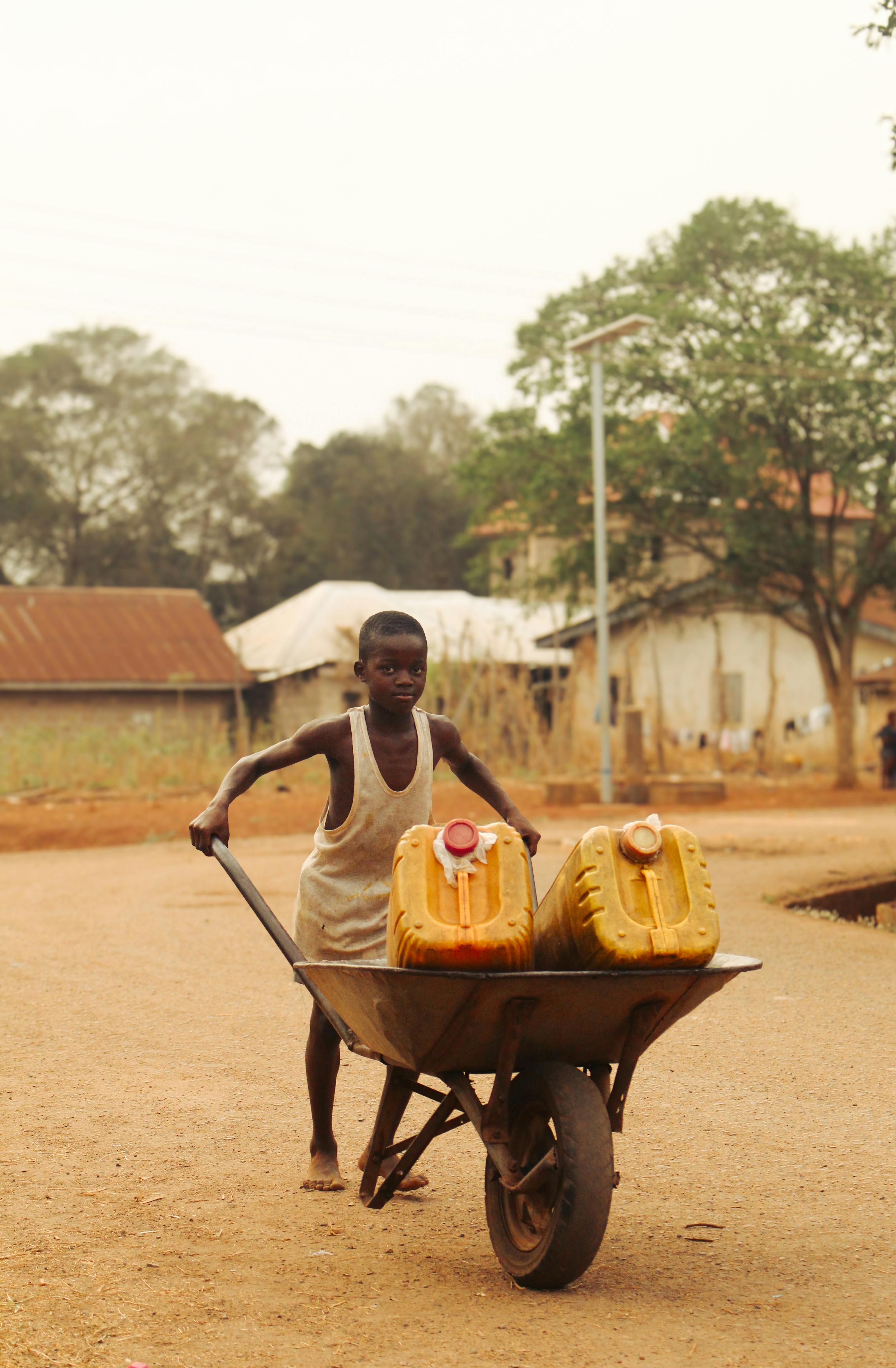 African Child Pushing Water in Enugu, Nigeria · Free Stock Photo
