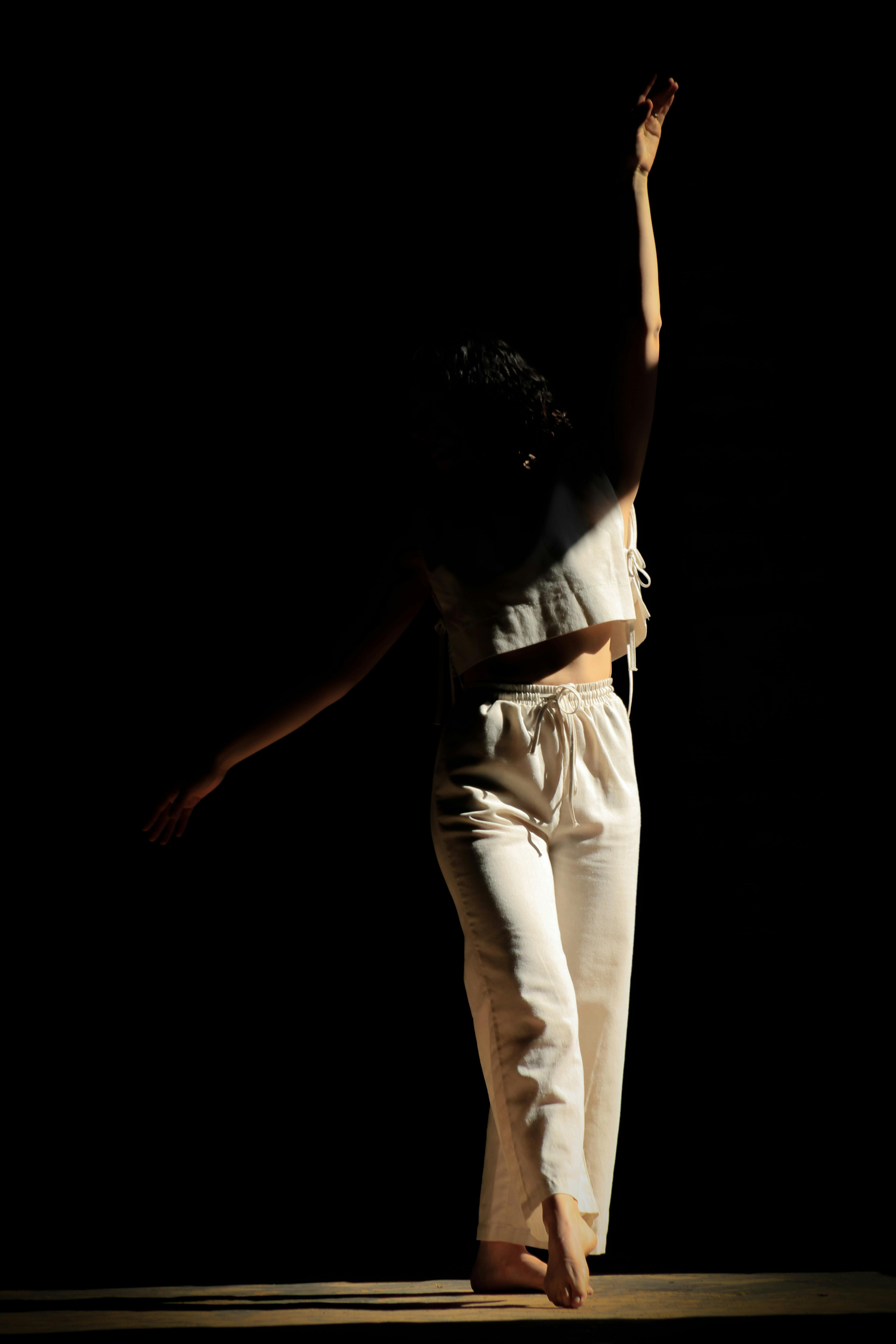 Elegant Dance Pose in Dramatic Lighting · Free Stock Photo