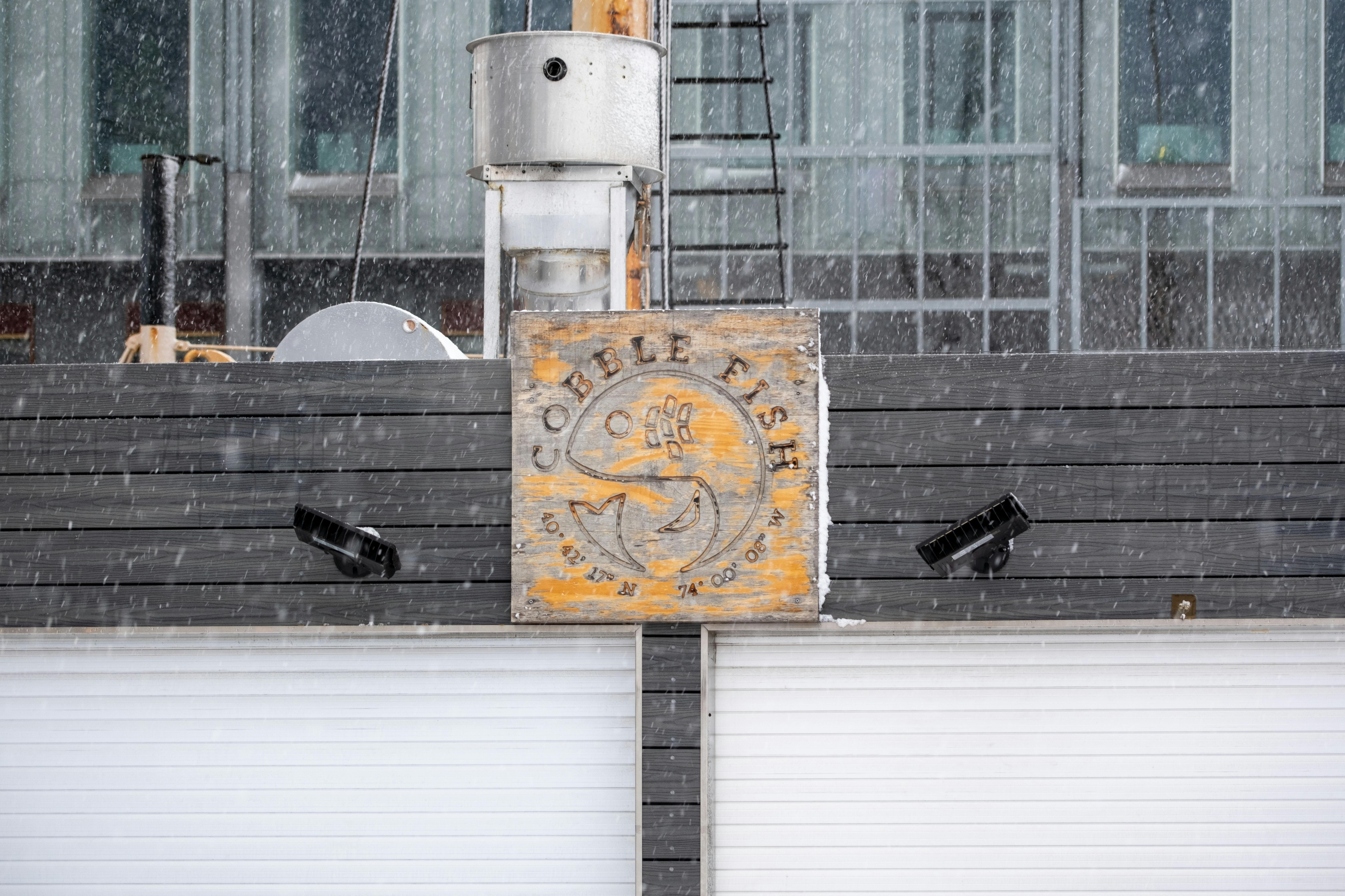 Snowy Urban Waterfront with Branding Signage · Free Stock Photo