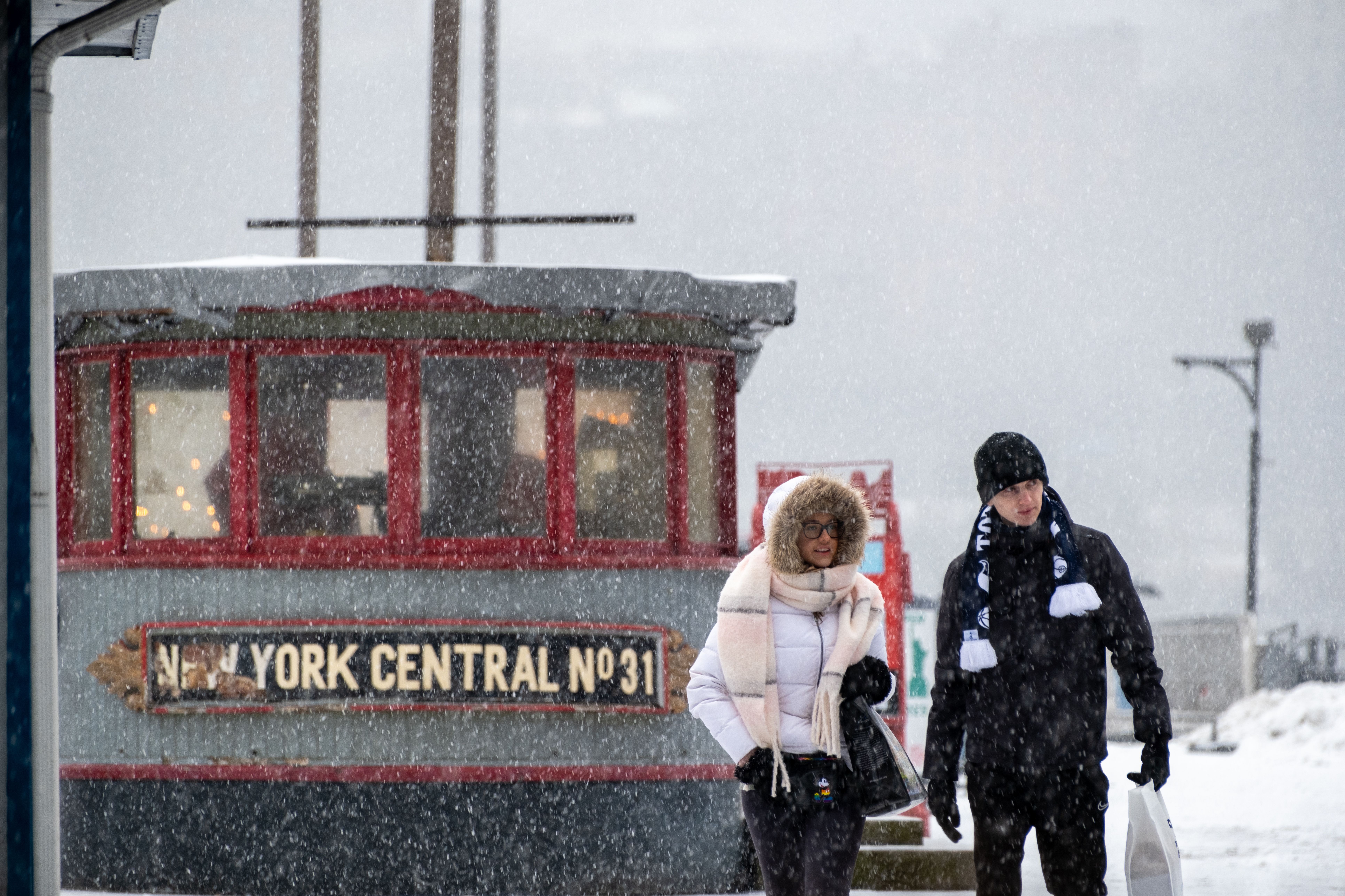 Urban Winter Scene in Snowstorm with Pedestrians · Free Stock Photo