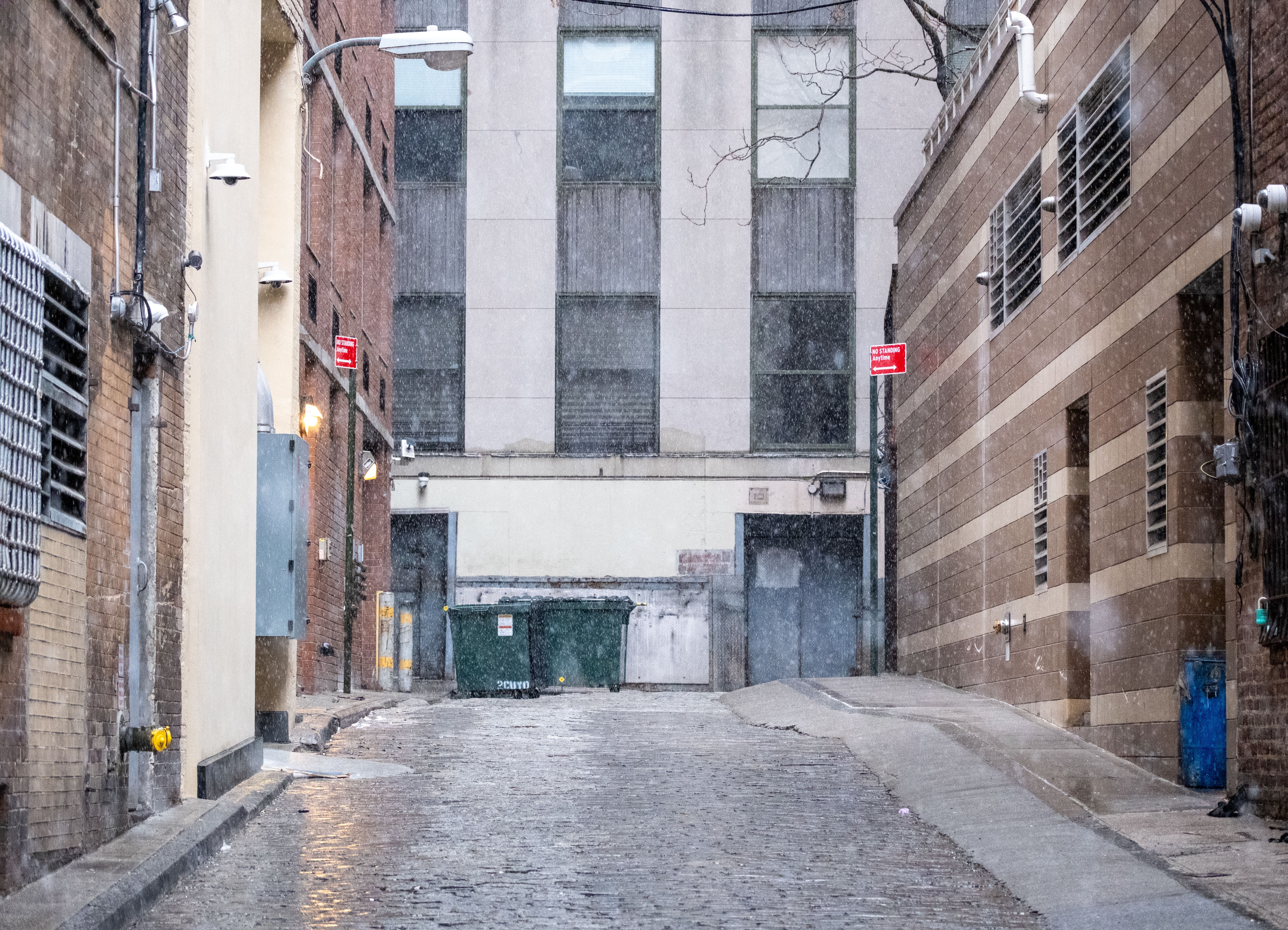 Winter City Alleyway with Cobblestones and Snowfall · Free Stock Photo