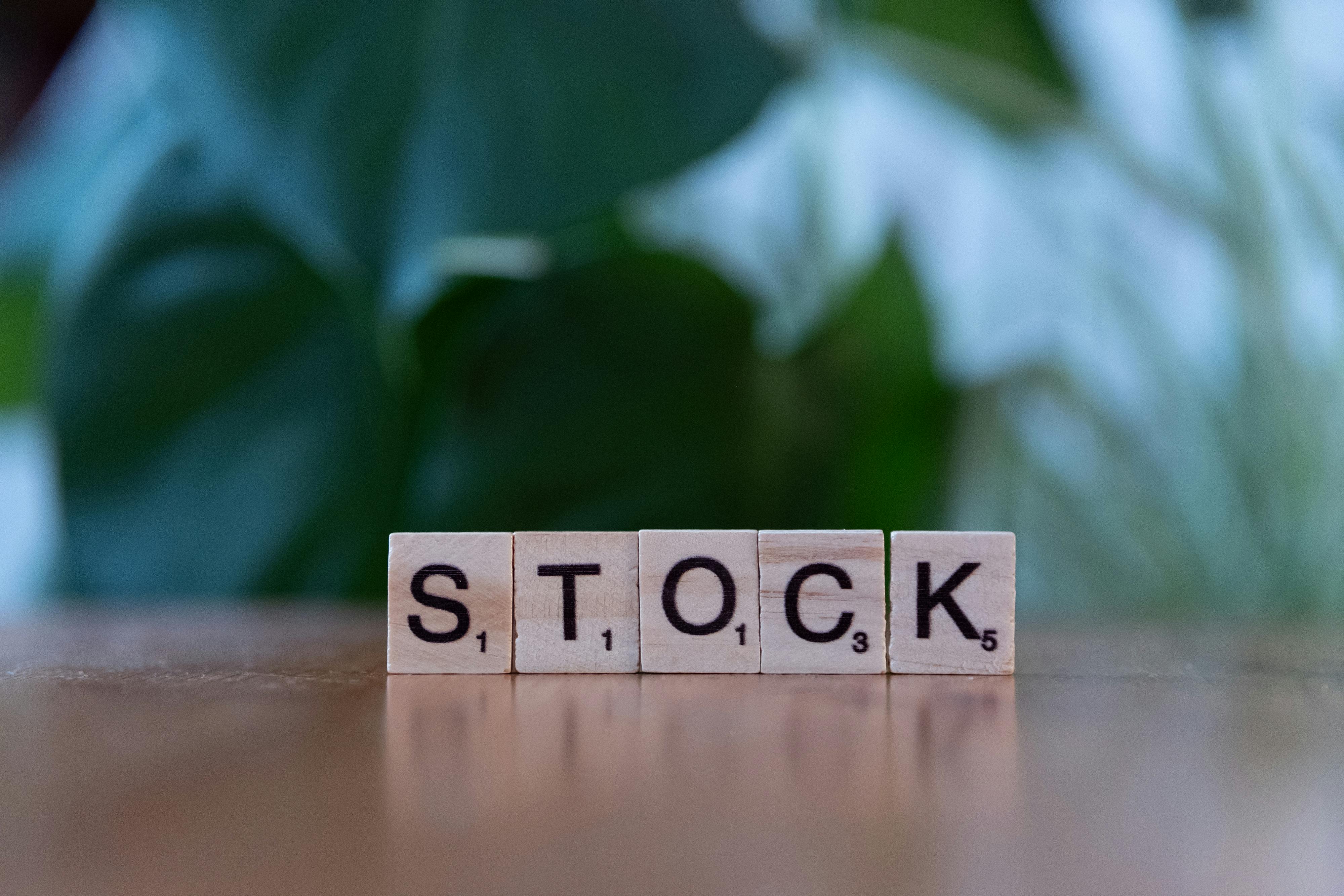 Wooden Letter Blocks Spelling 'Stock' on Table · Free Stock Photo