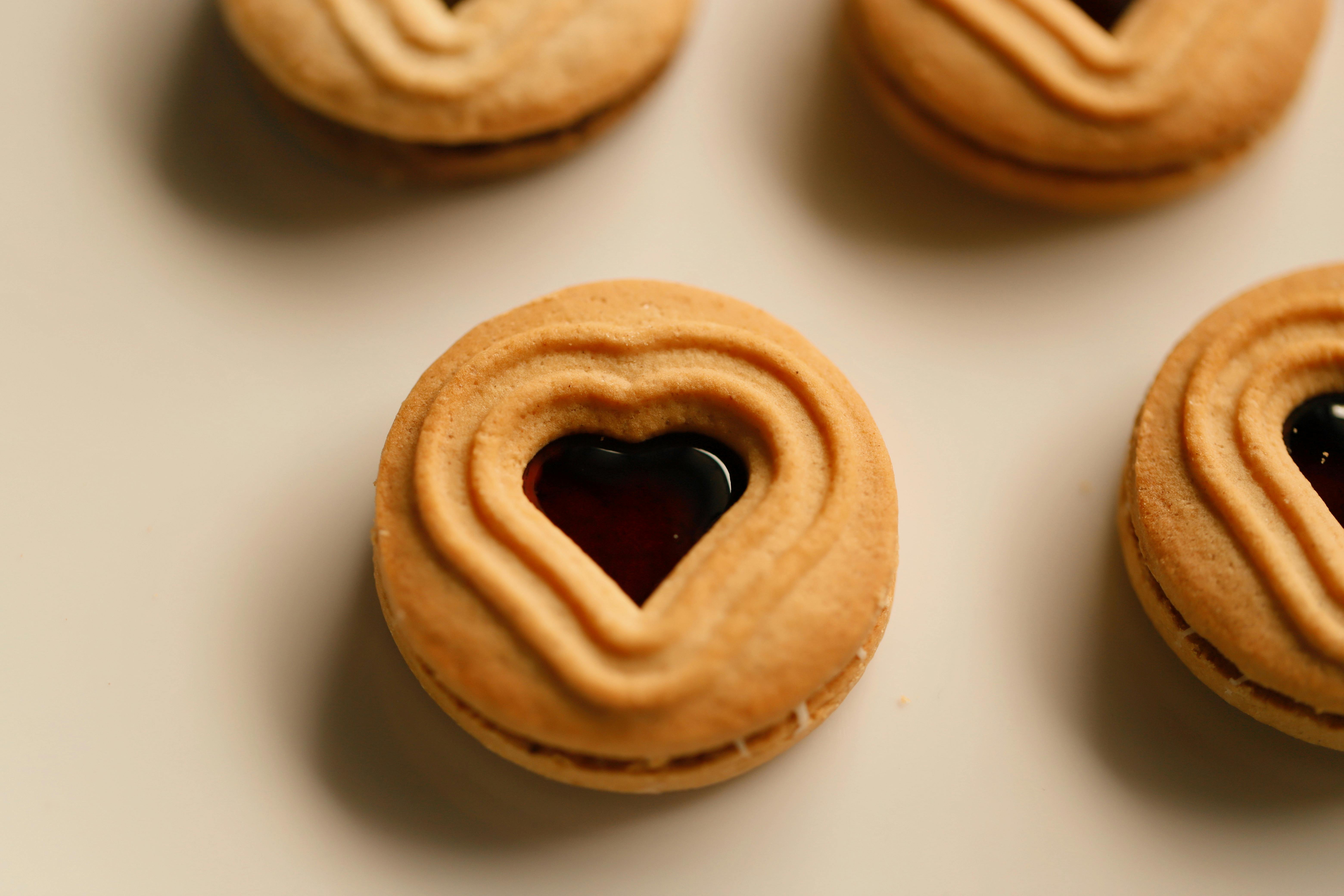 Heart-Shaped Jam-Filled Biscuits On Table · Free Stock Photo