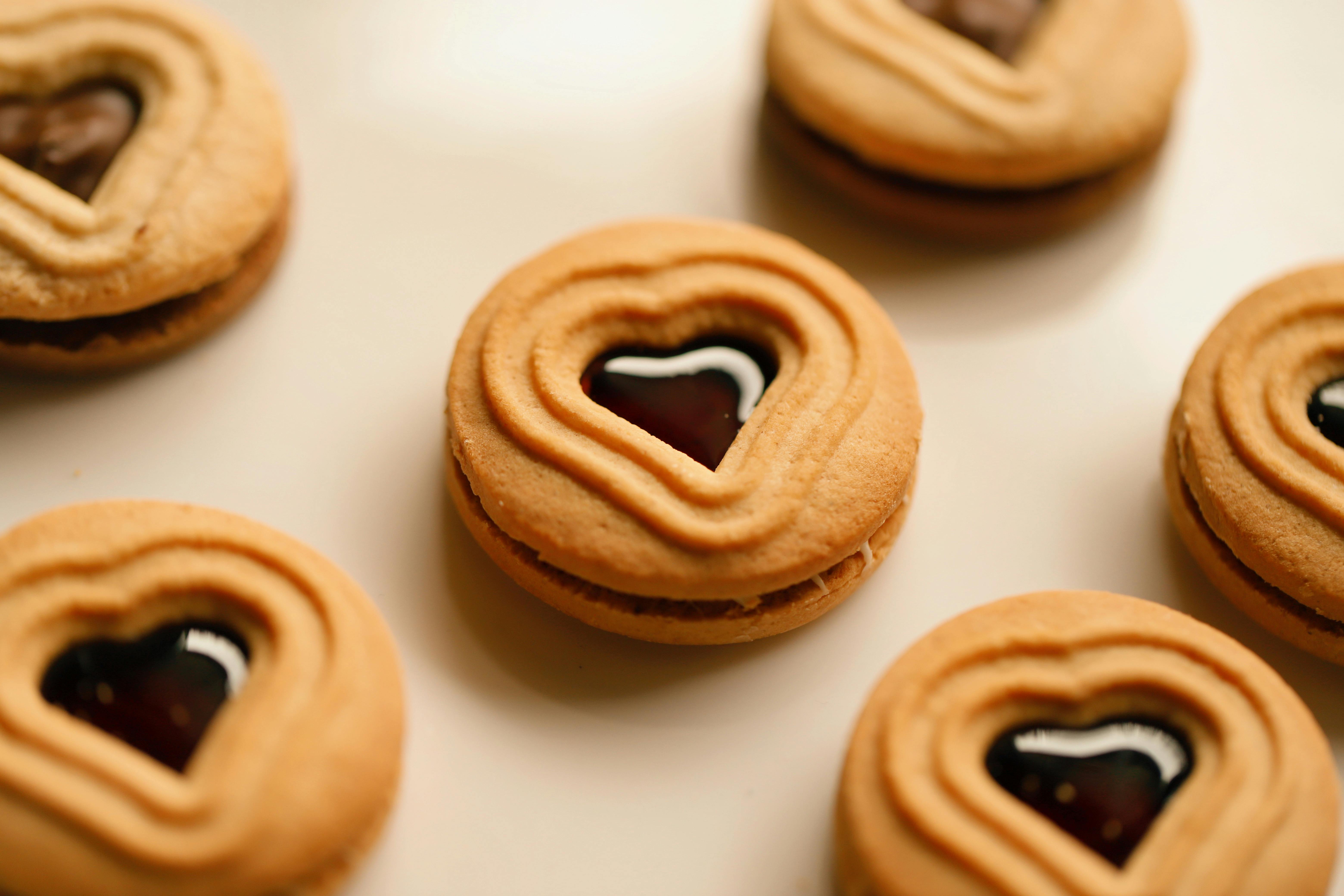 Heart-Shaped Jam Biscuits on White Surface · Free Stock Photo
