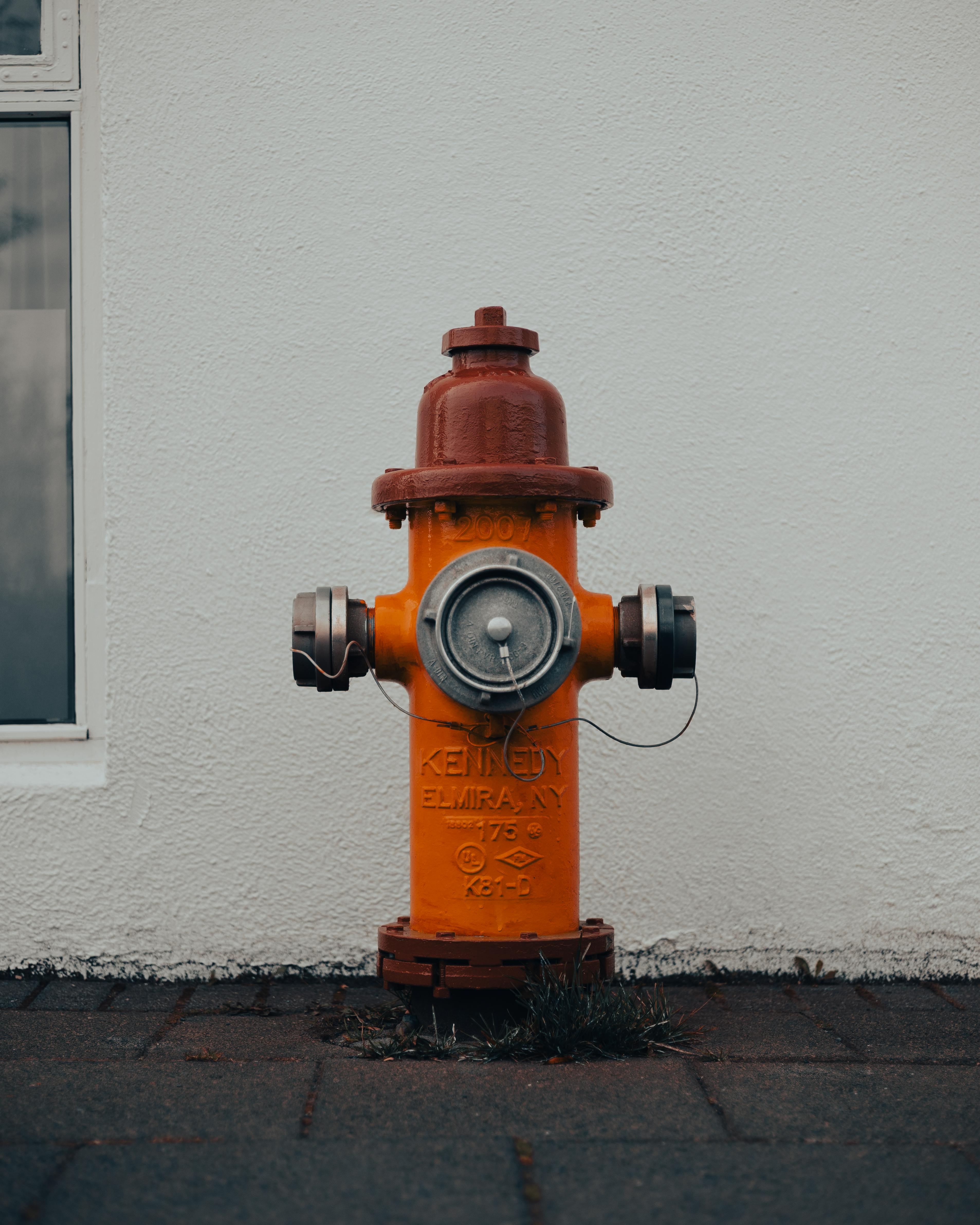 Vibrant Orange Fire Hydrant against White Wall in Iceland · Free Stock ...