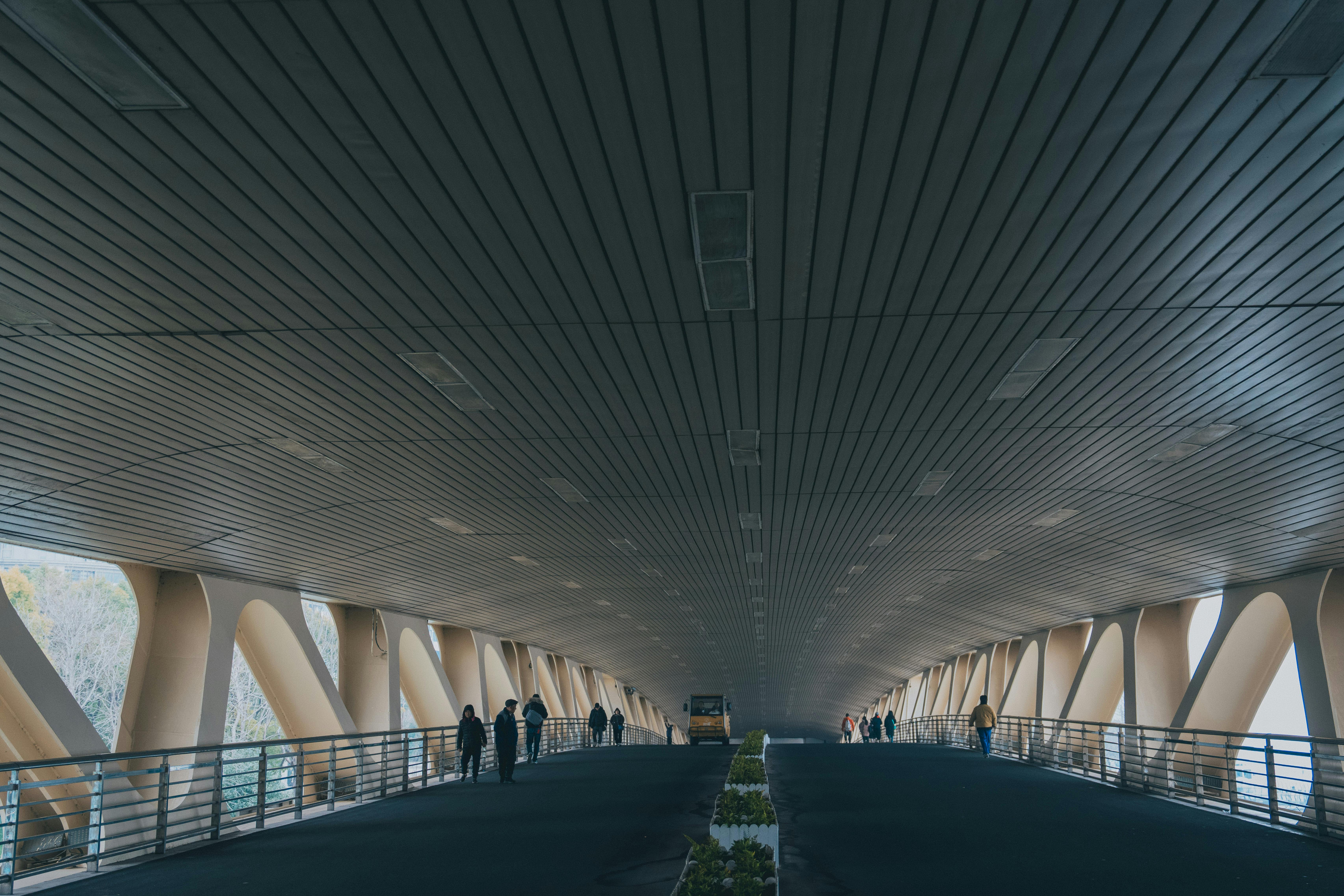 Modern Overpass with Pedestrians Walking Below · Free Stock Photo