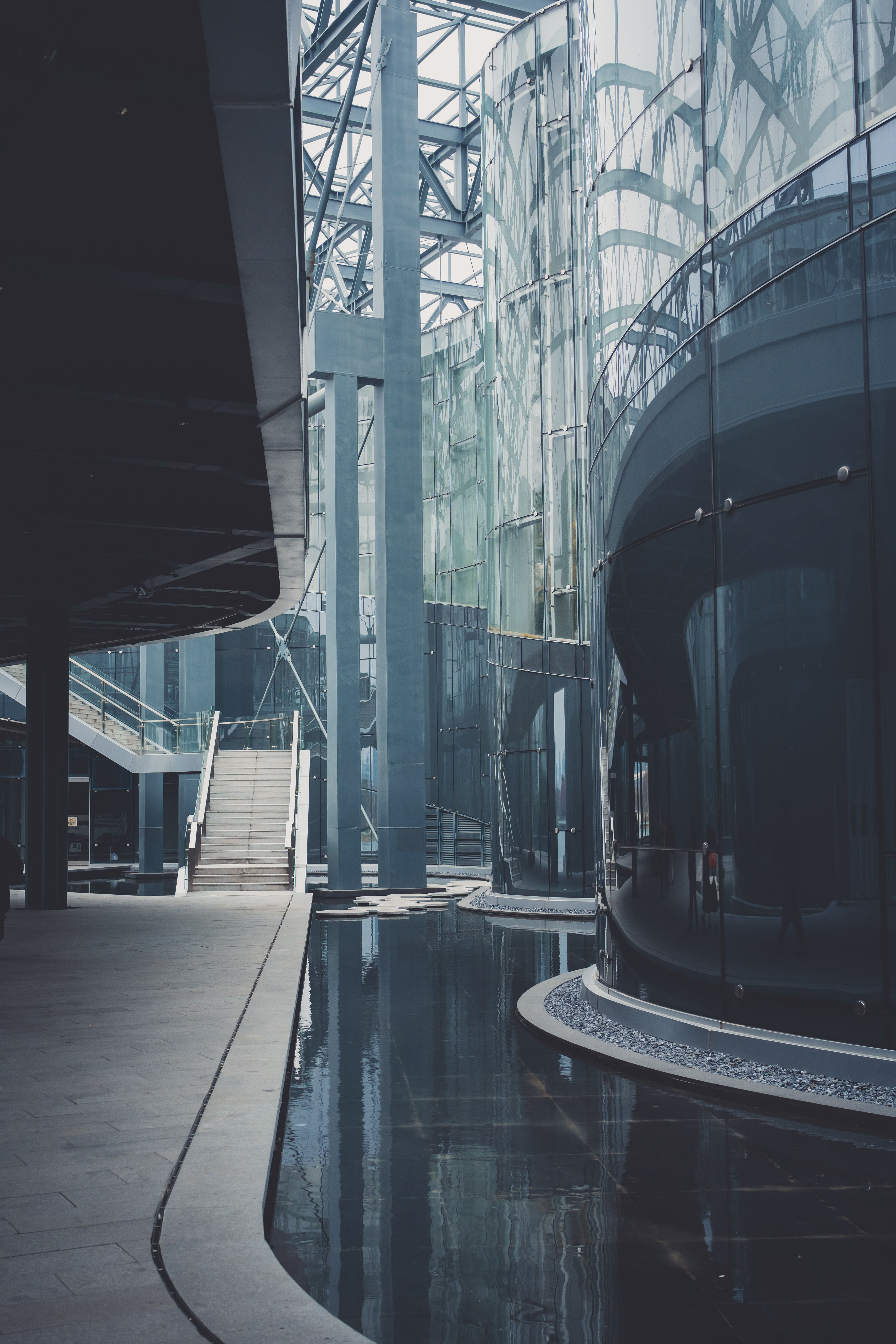 Modern Glass Architecture with Reflective Water · Free Stock Photo