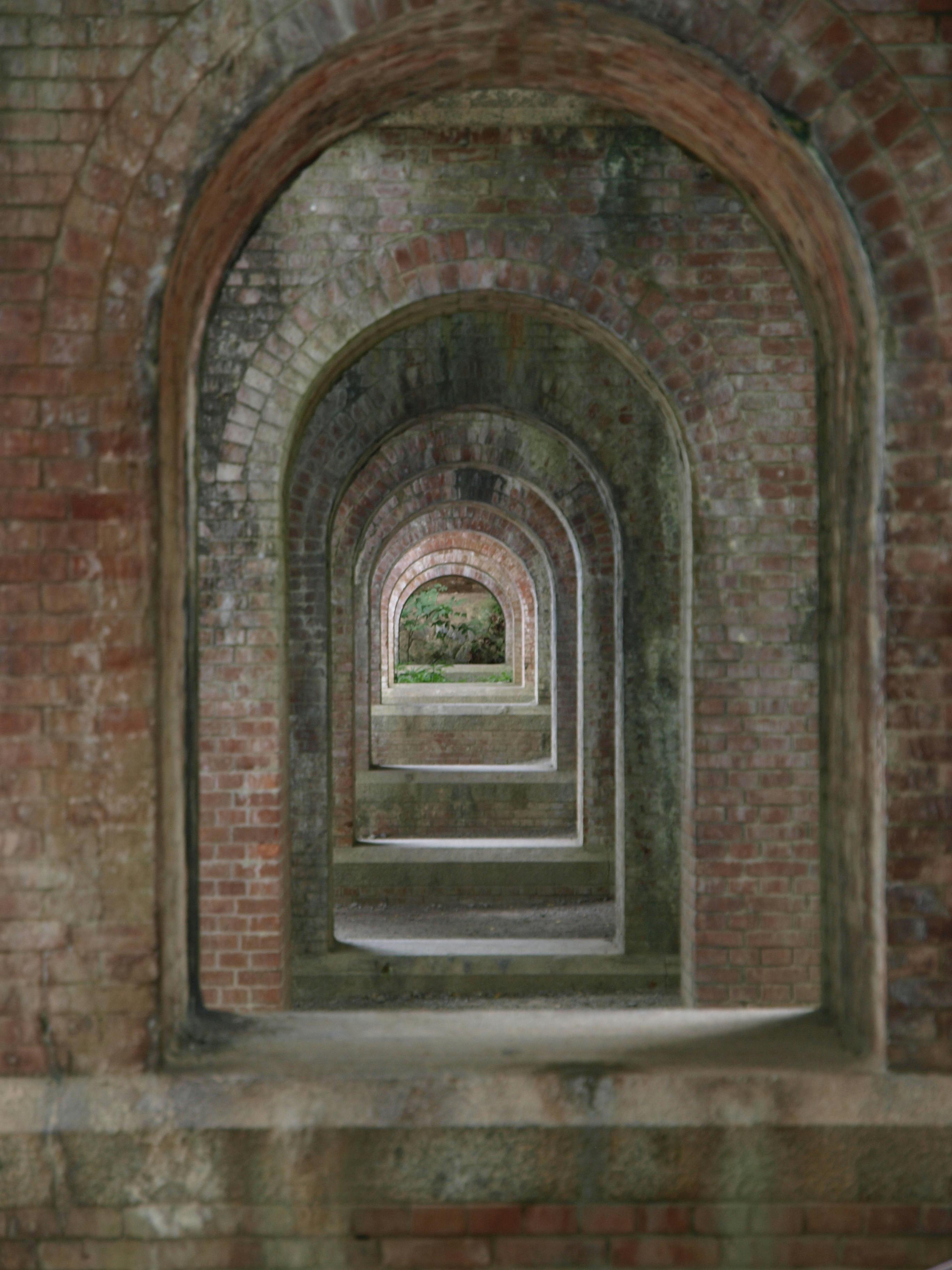 Historic Brick Archway Corridor Perspective · Free Stock Photo