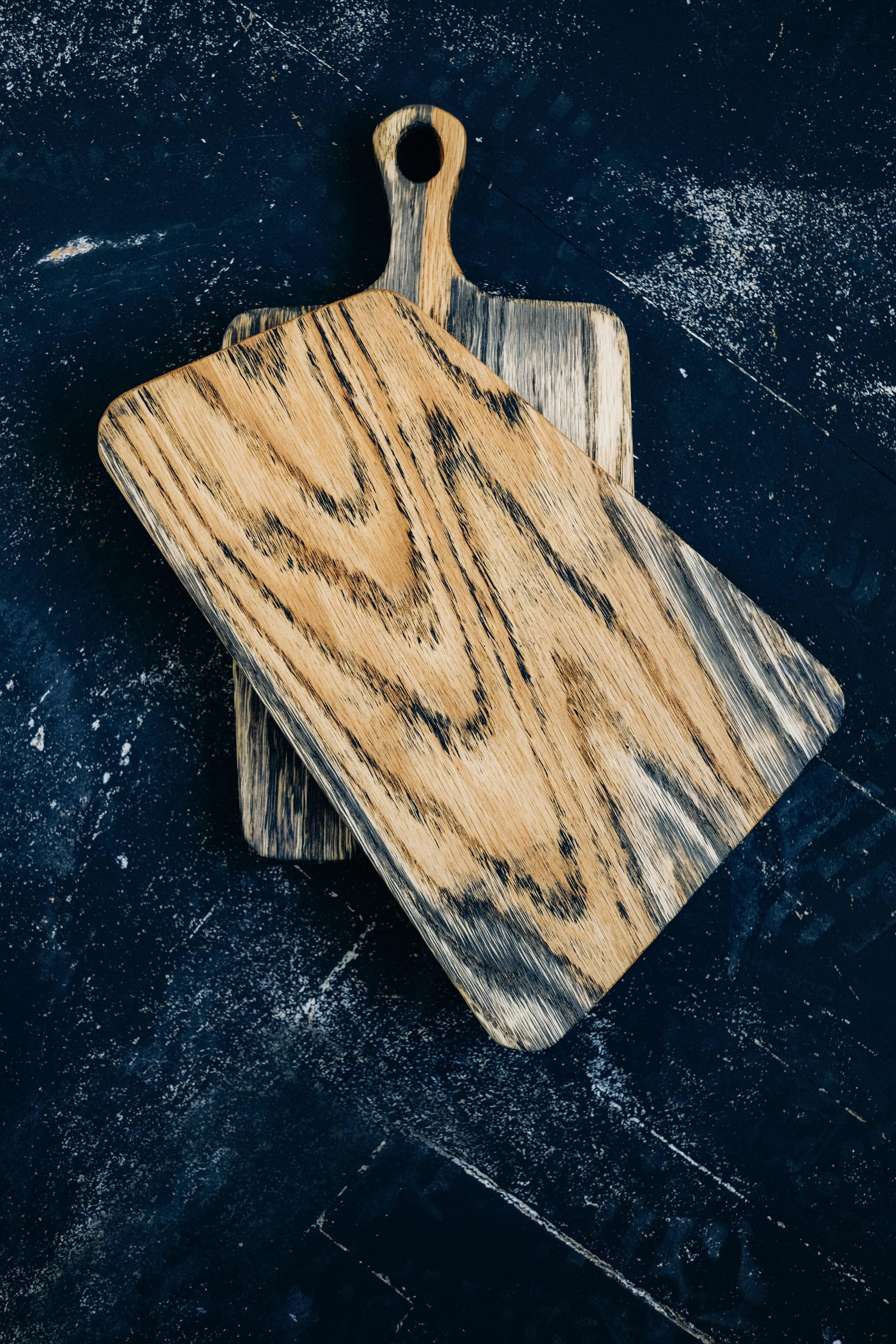 Rustic Wooden Cutting Boards on Dark Surface · Free Stock Photo