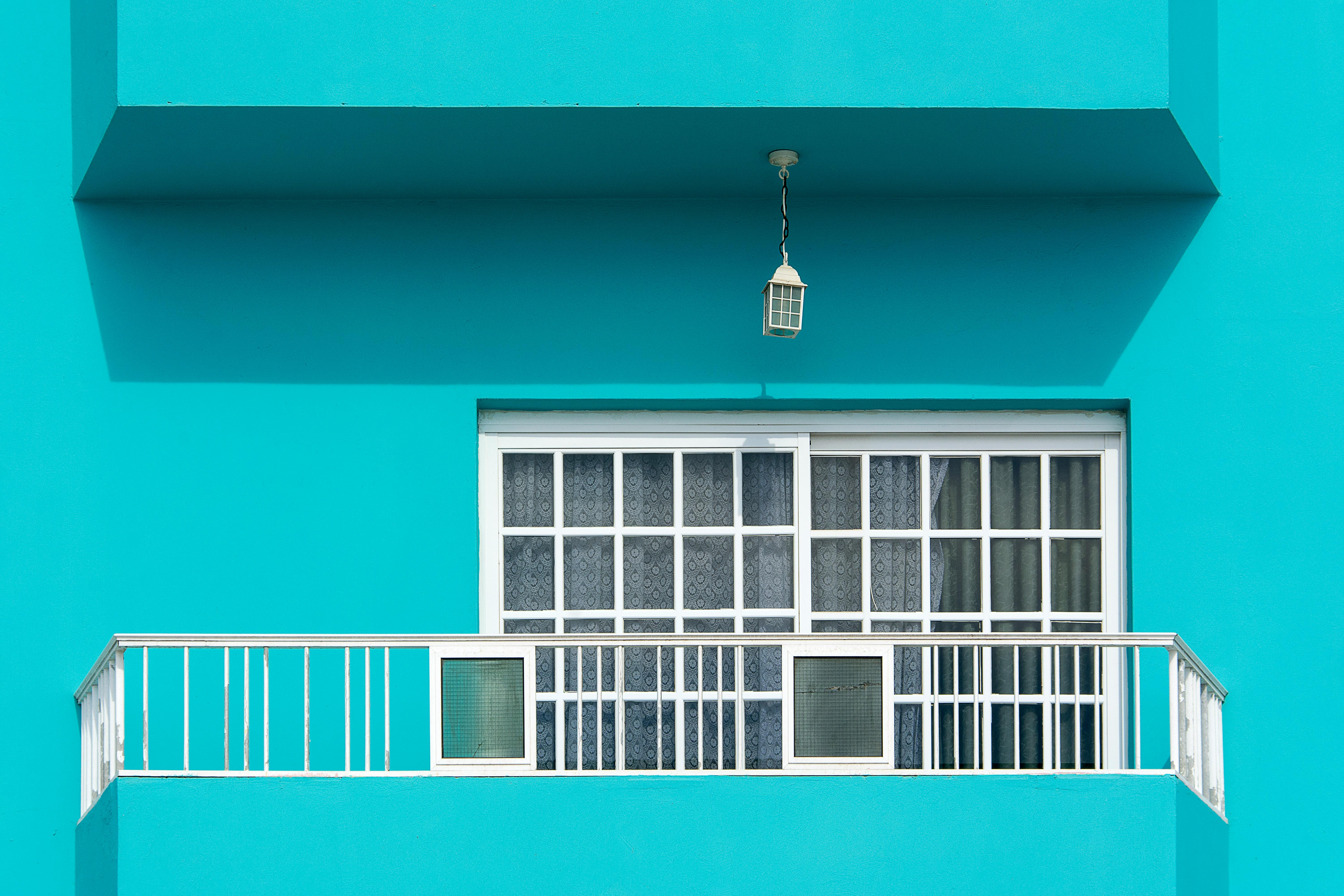 Minimalist Teal Building Facade with Balcony · Free Stock Photo